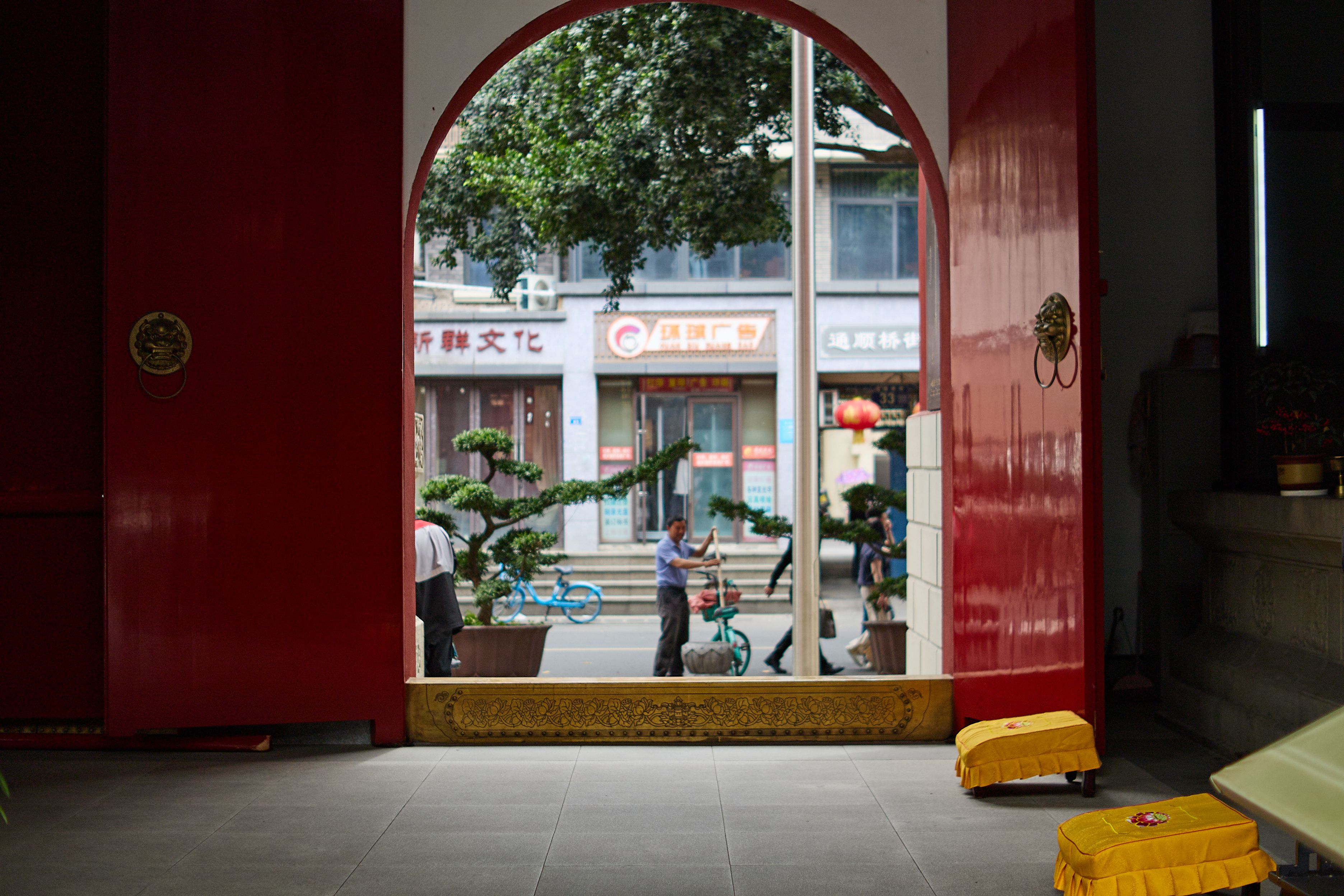 Traditional Red Chinese Doorway to Bustling Street · Free Stock Photo
