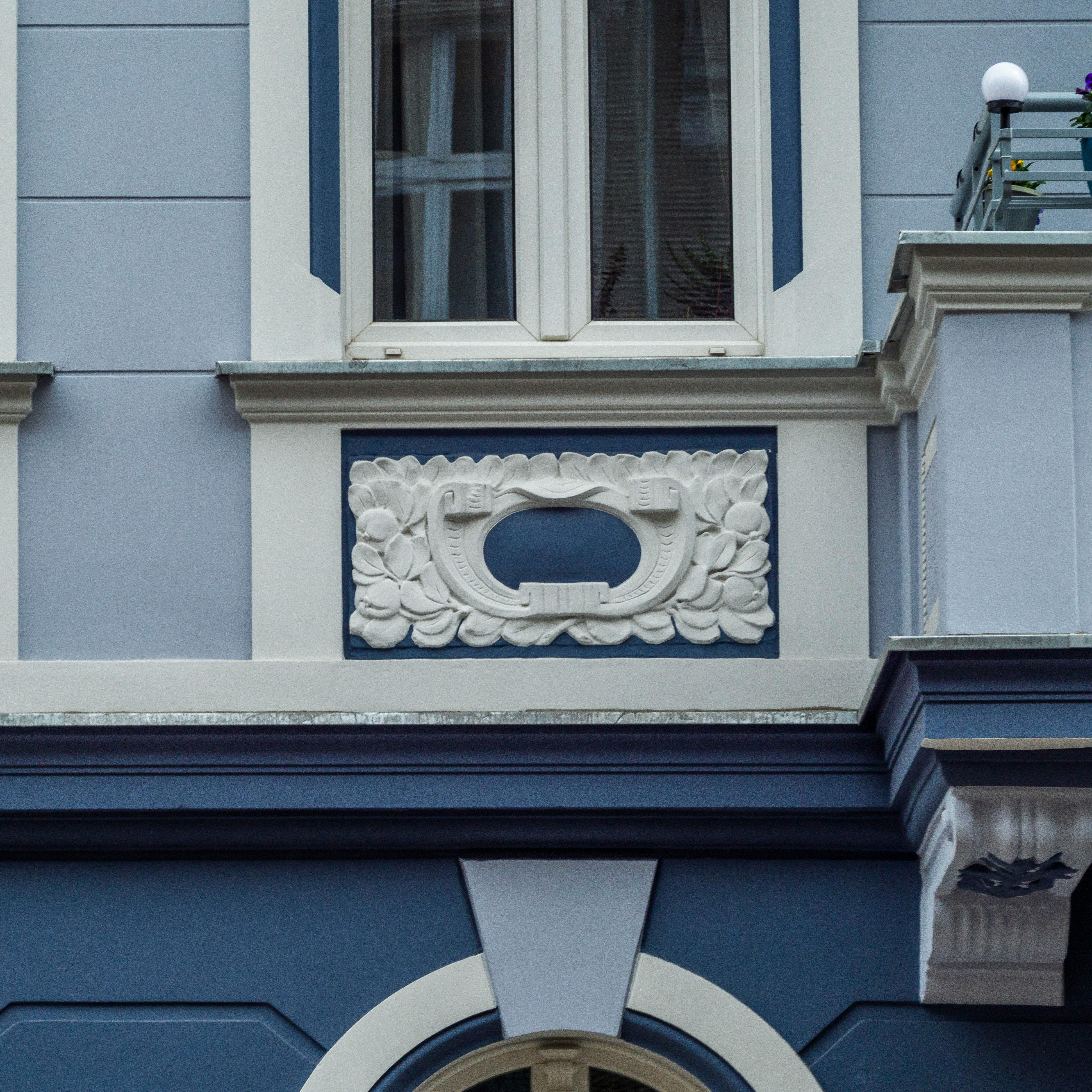 Elegant Blue Building Facade with Ornate Details · Free Stock Photo