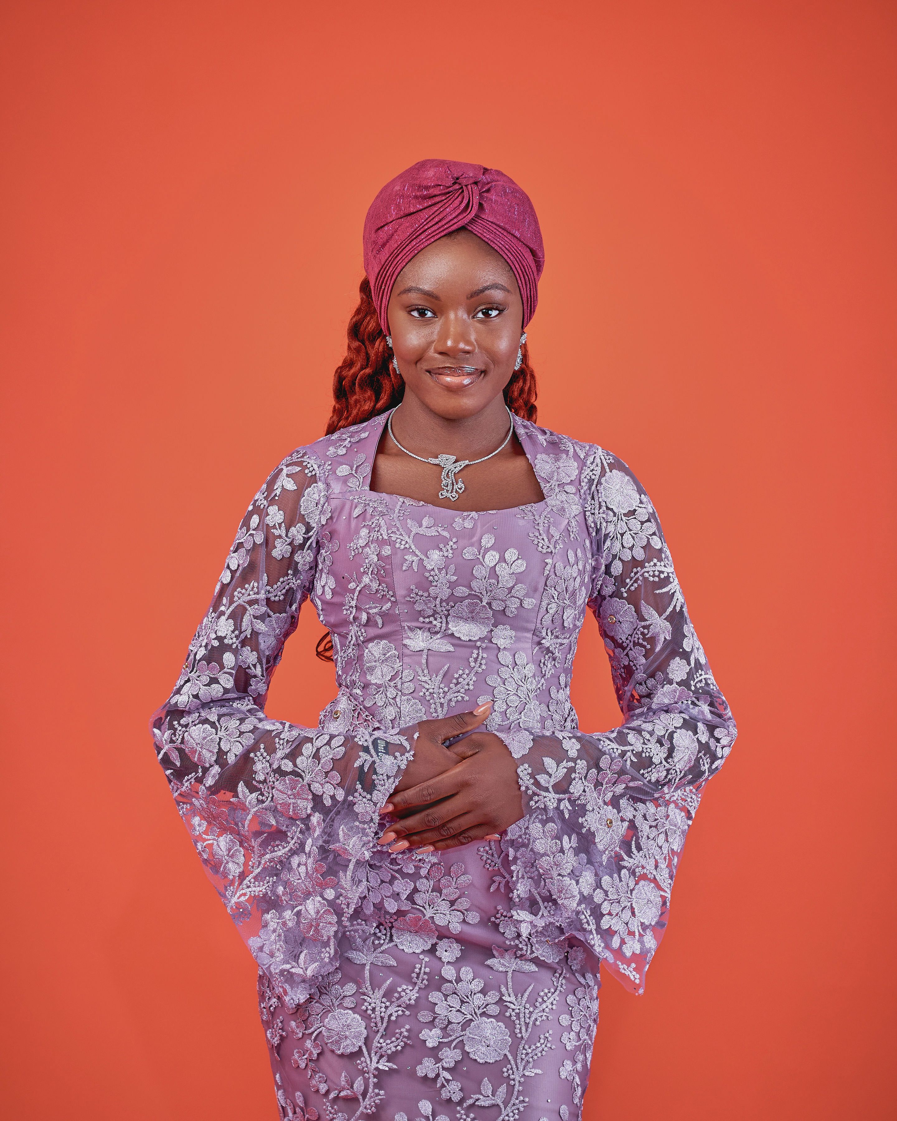 Elegant Woman in Traditional Attire on Orange Background · Free Stock Photo