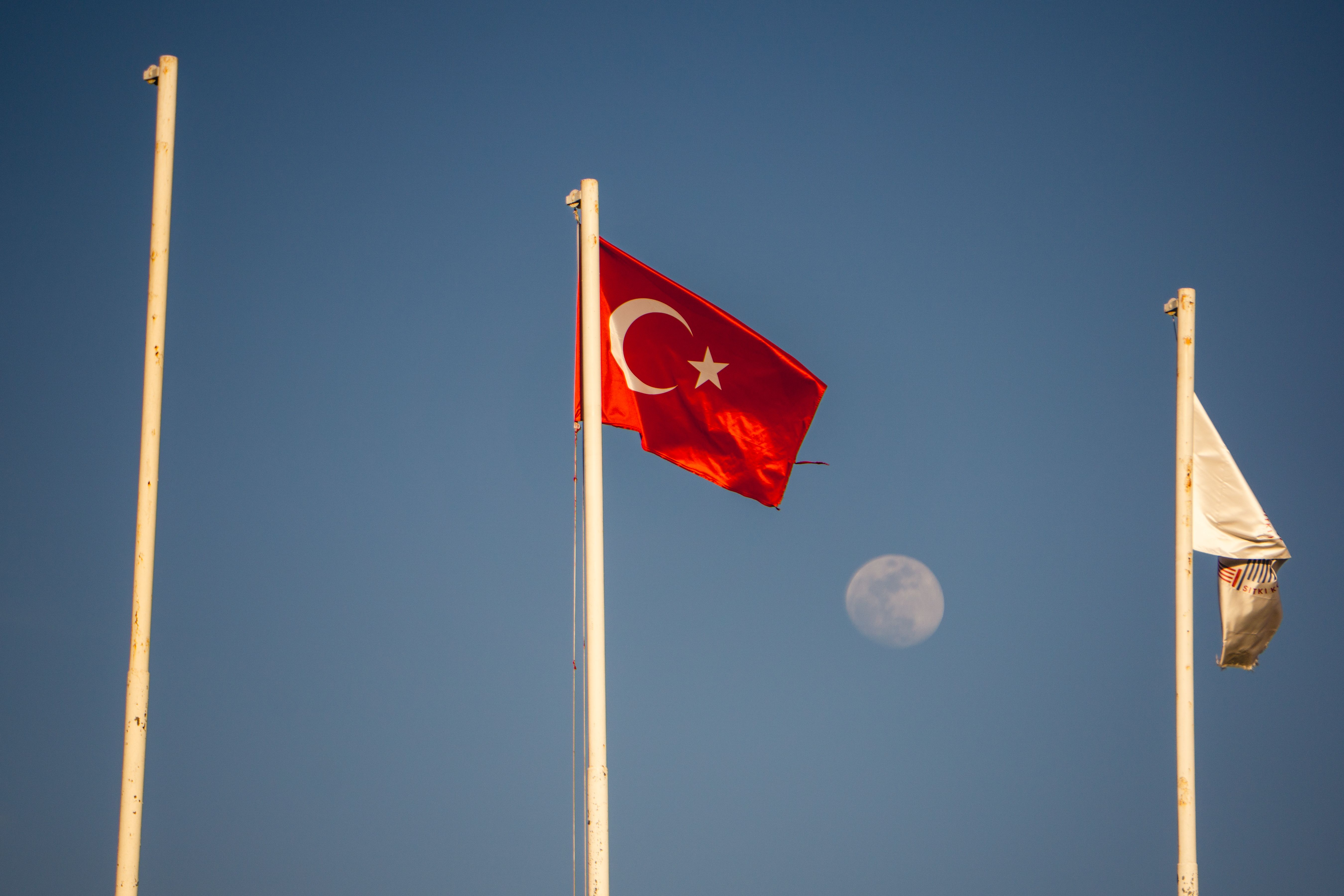 Turkish Flag with Moon in Clear Blue Sky · Free Stock Photo
