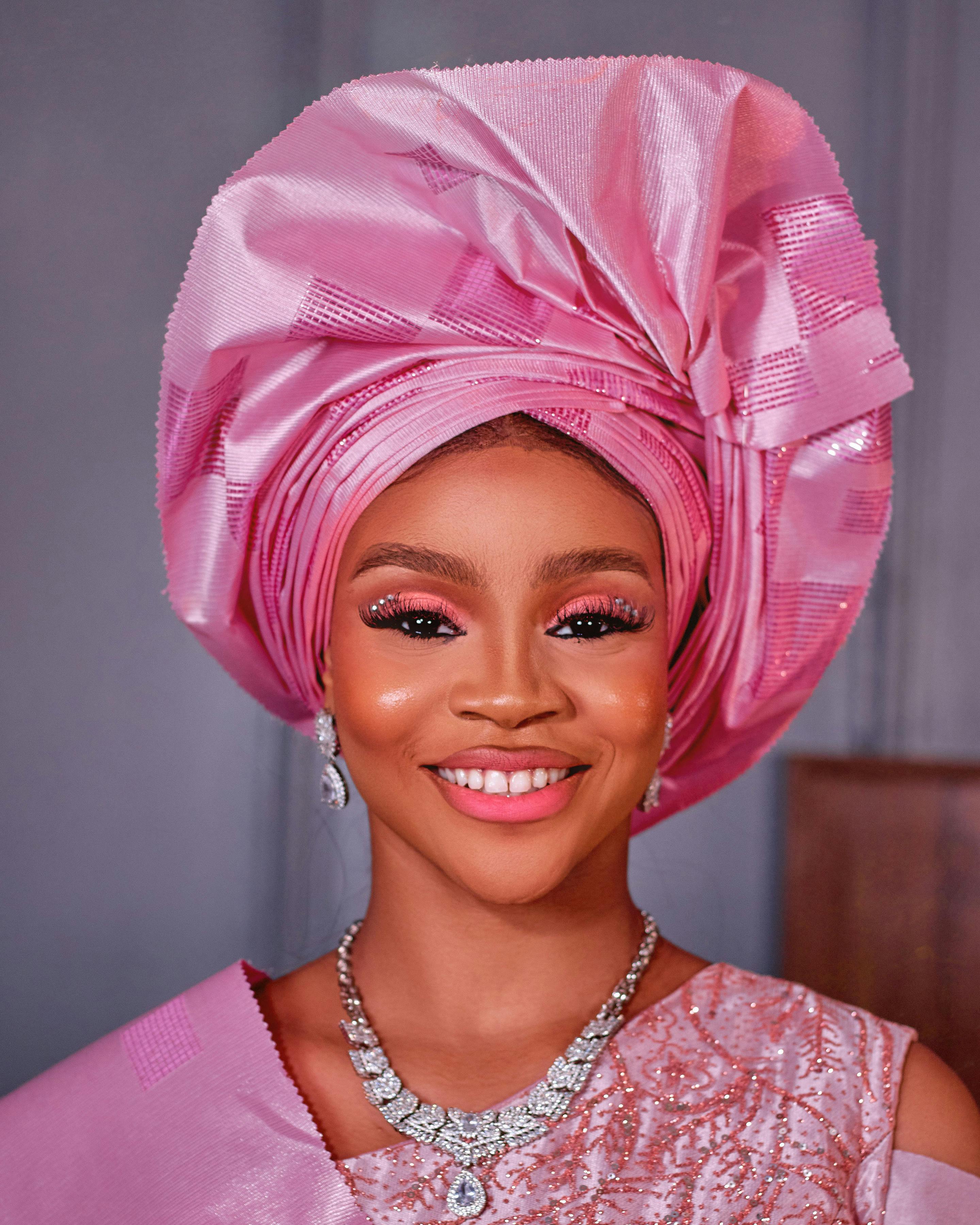 Elegant Woman in Traditional Pink Gele and Attire · Free Stock Photo