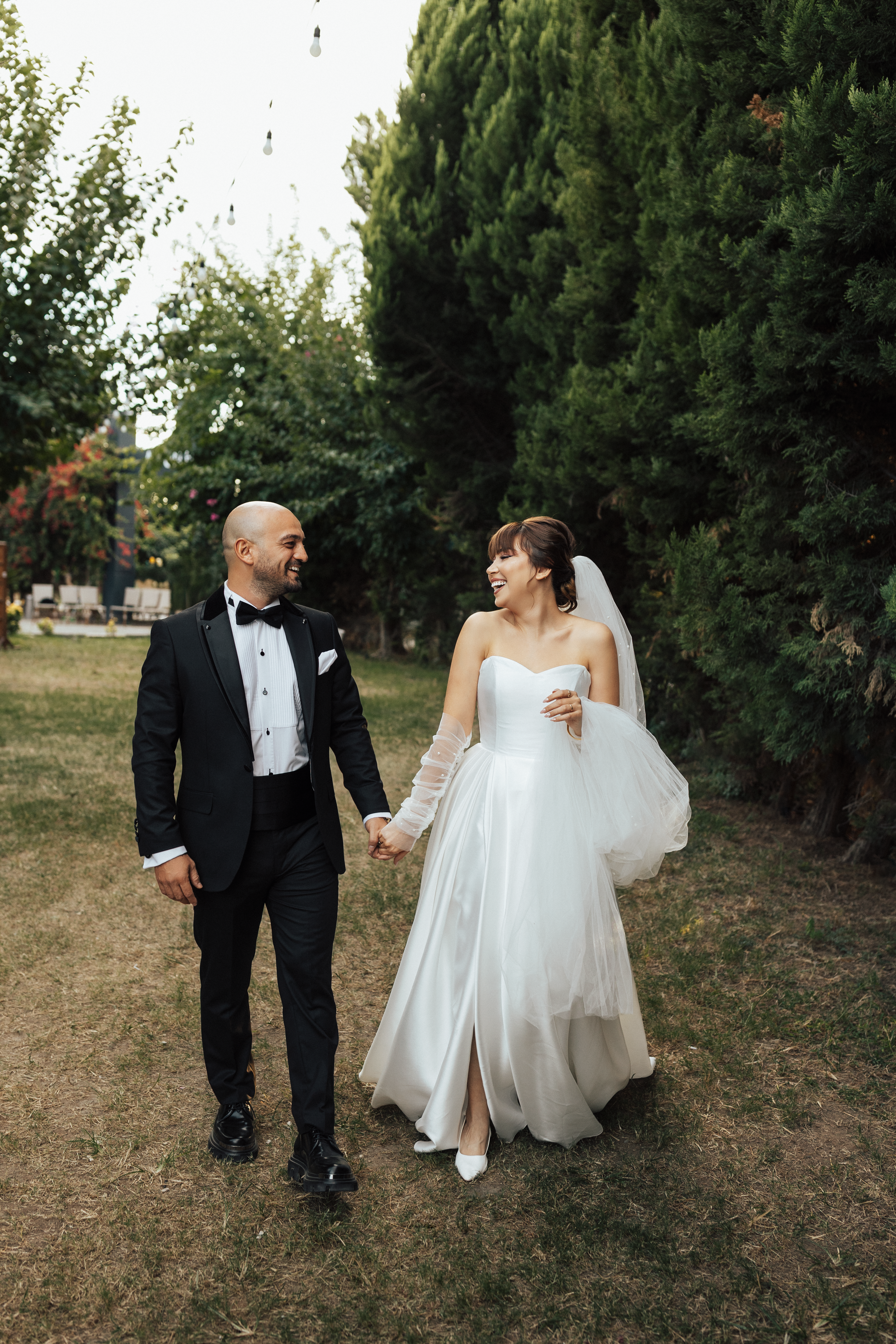 Joyful Bride and Groom Walking Outdoors · Free Stock Photo