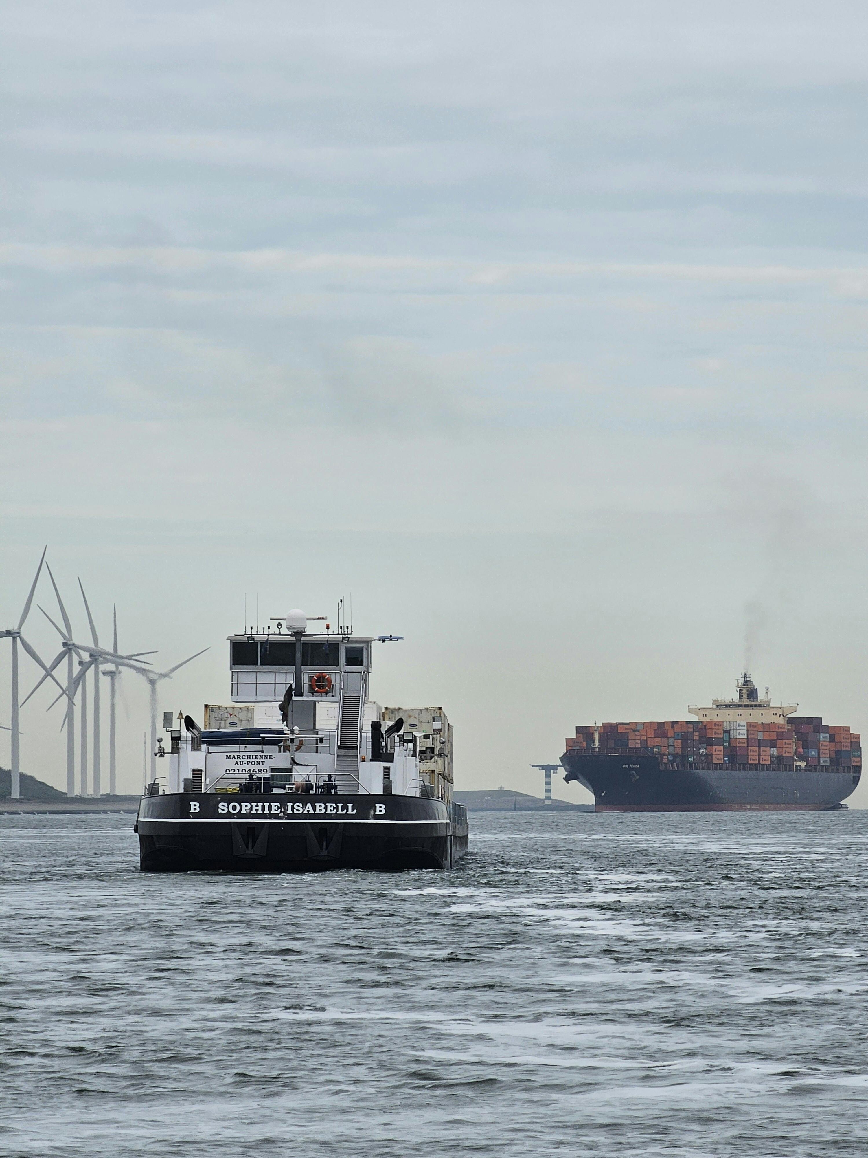 Cargo ships and wind turbines in Maasvlakte port · Free Stock Photo