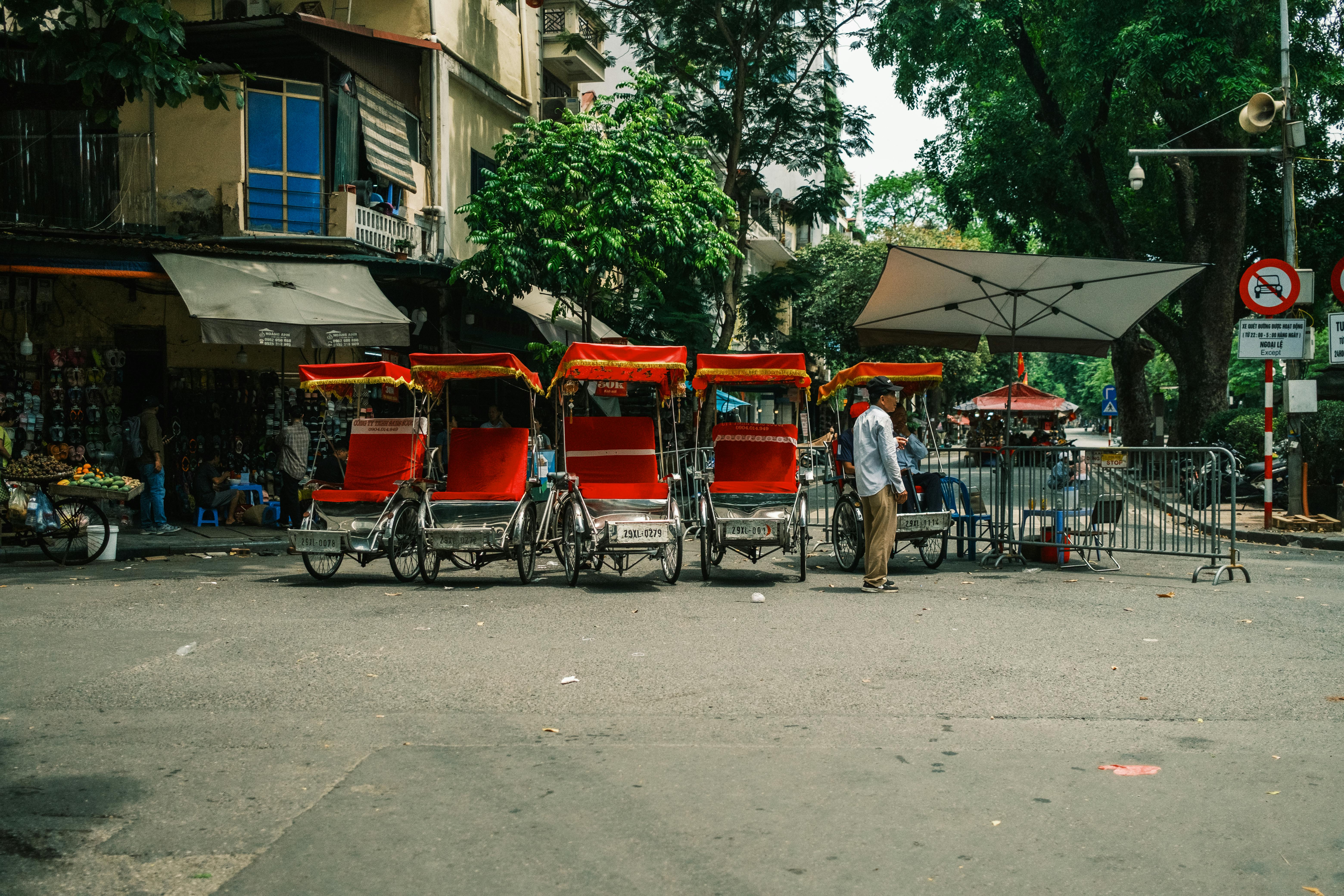 Hanoi Street Scene with Traditional Rickshaws · Free Stock Photo