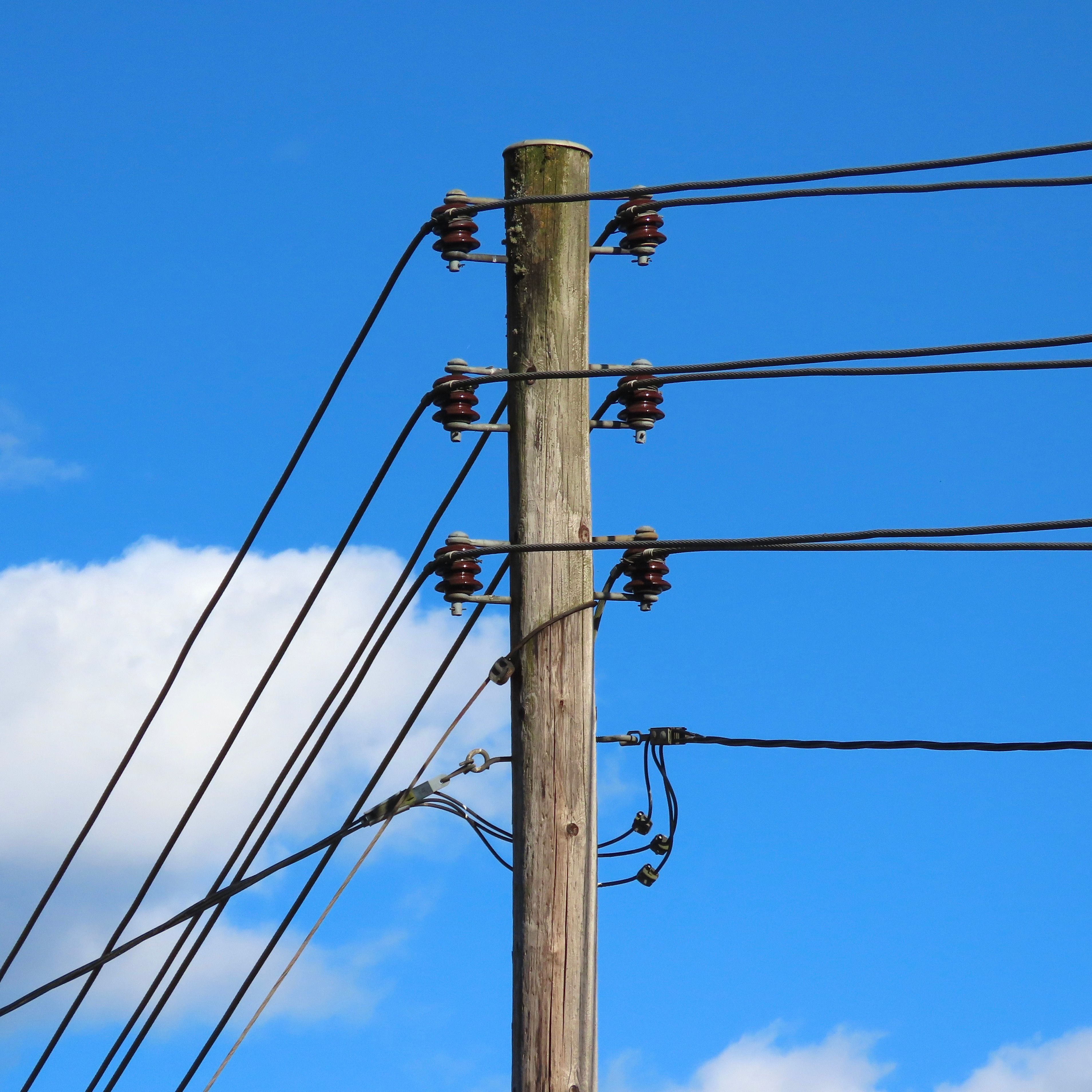 Electricity Pole Against Bright Blue Sky · Free Stock Photo