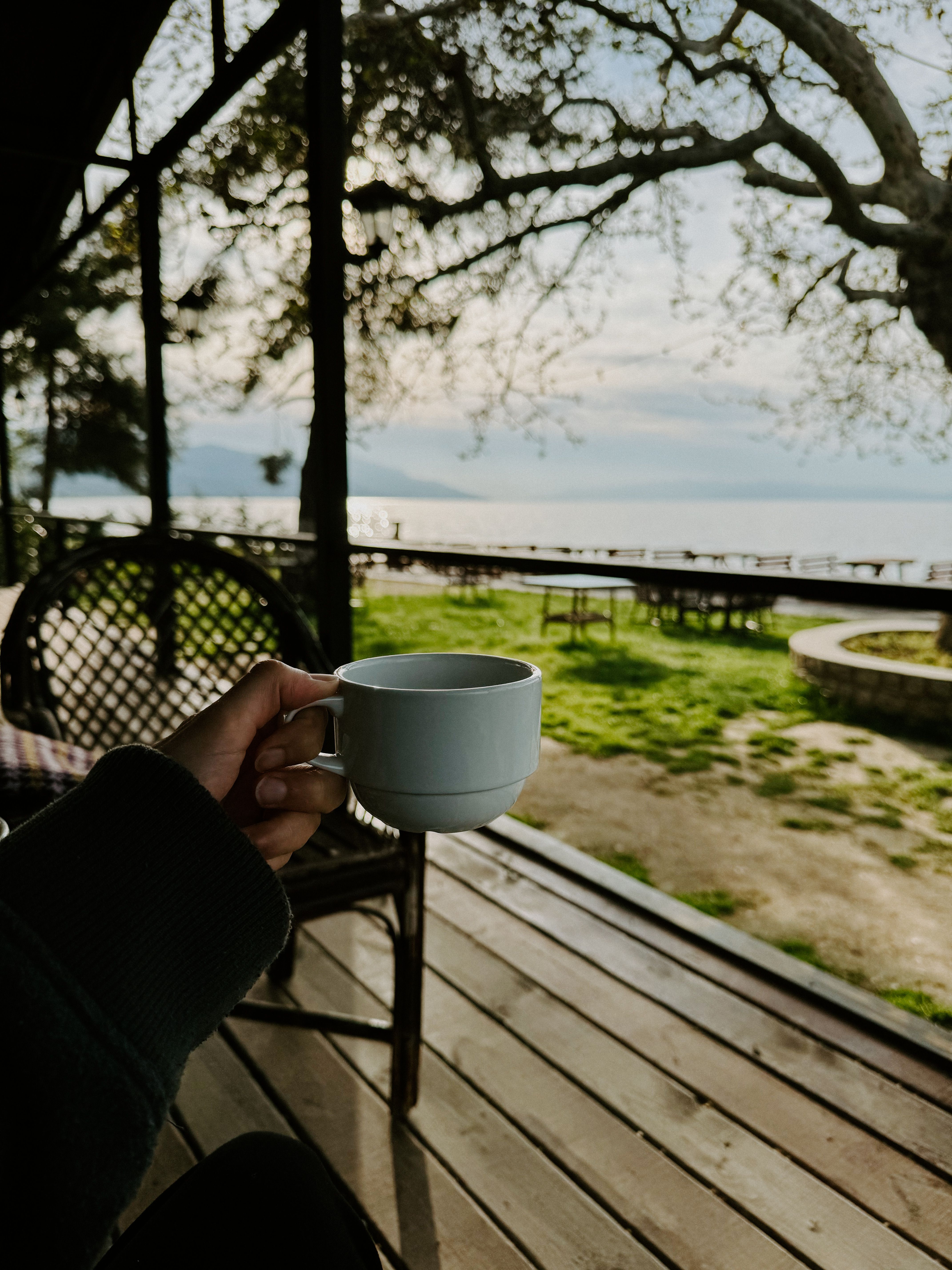 Scenic Outdoor Coffee on Wooden Deck by the Sea · Free Stock Photo