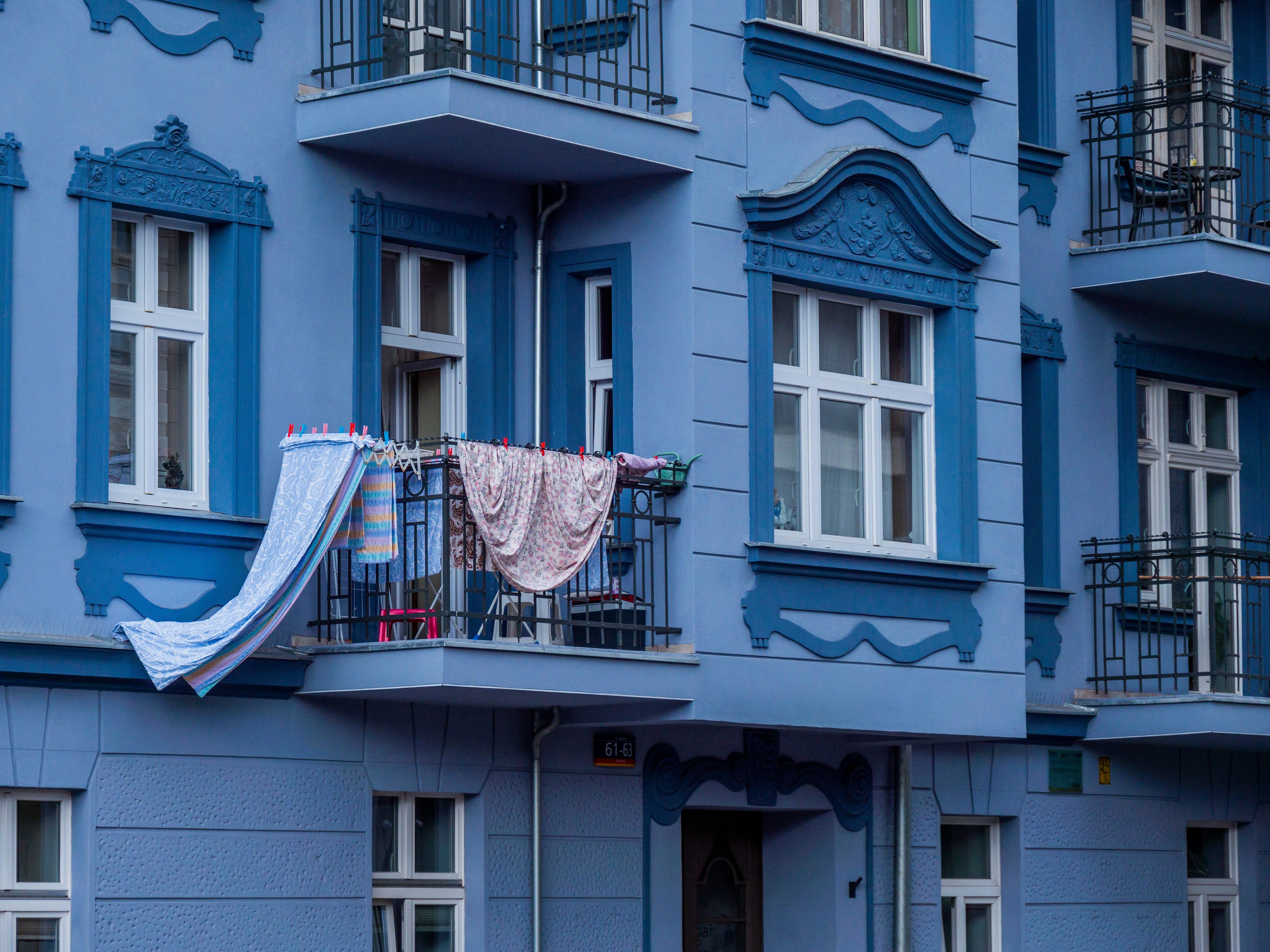 Blue Apartment Building with Balcony Laundry · Free Stock Photo
