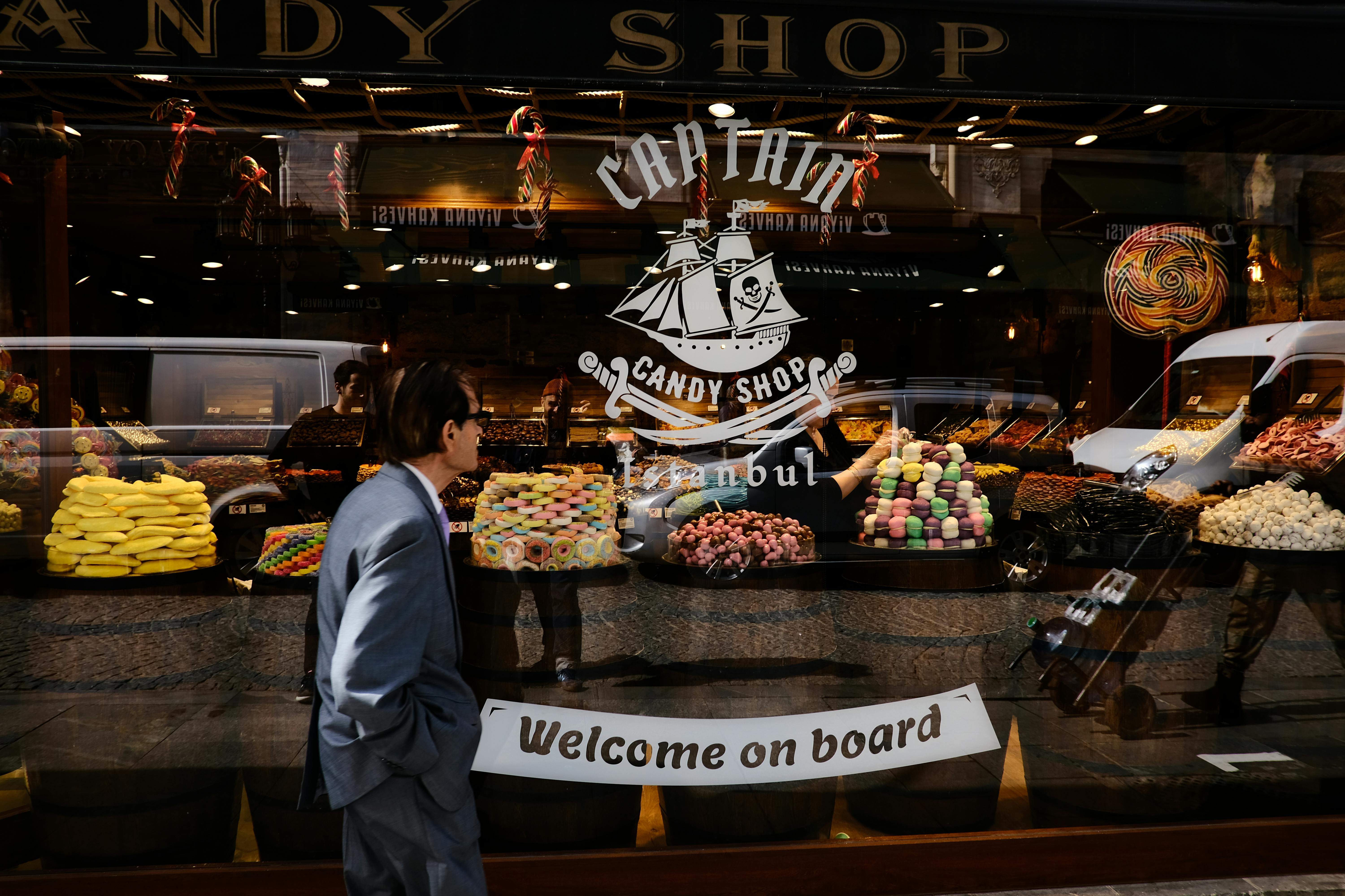 Stylish Individual in Front of Istanbul Candy Shop · Free Stock Photo