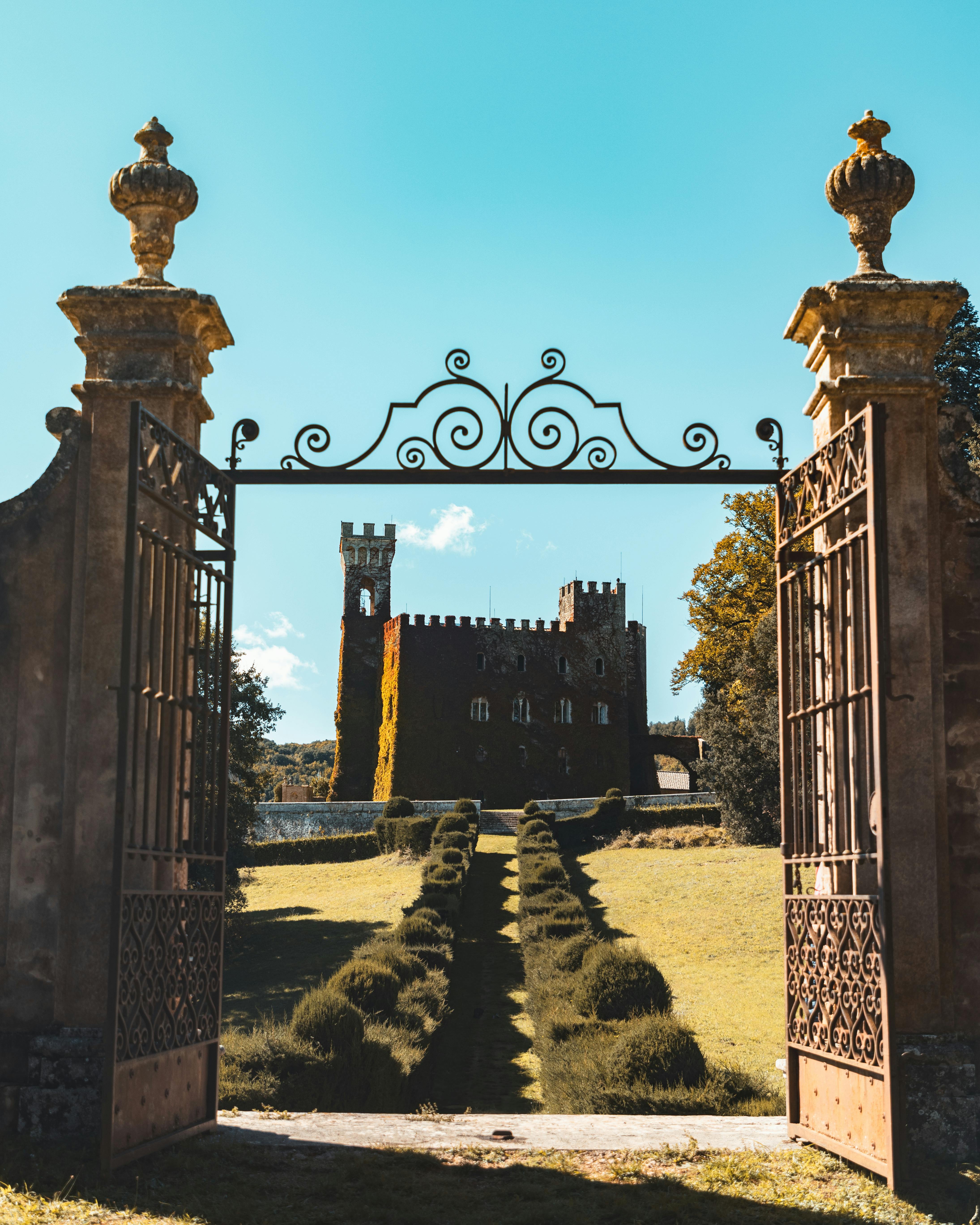Majestic Castle Through Open Iron Gate · Free Stock Photo
