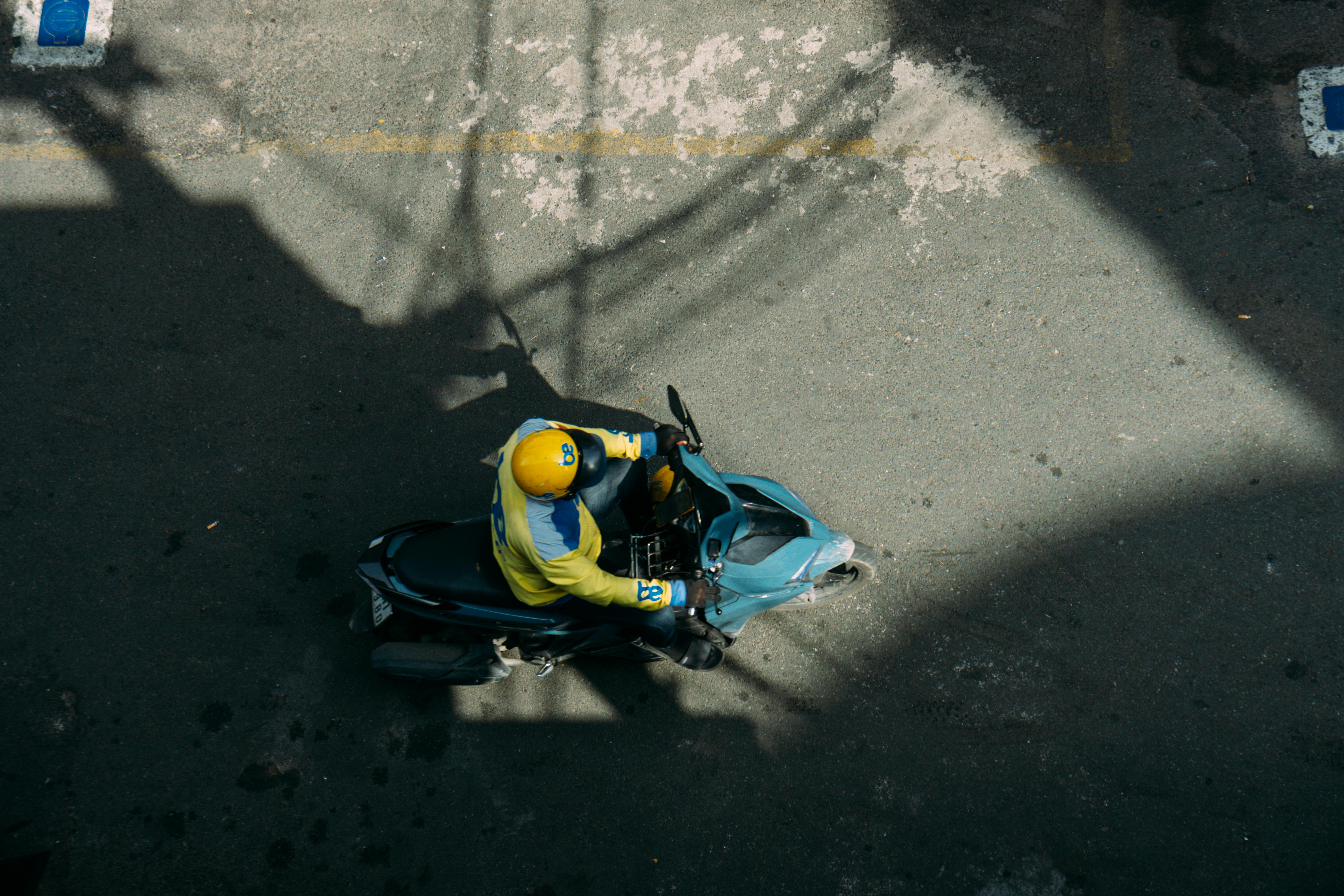 Aerial View of Scooter Rider on Sunny Street · Free Stock Photo