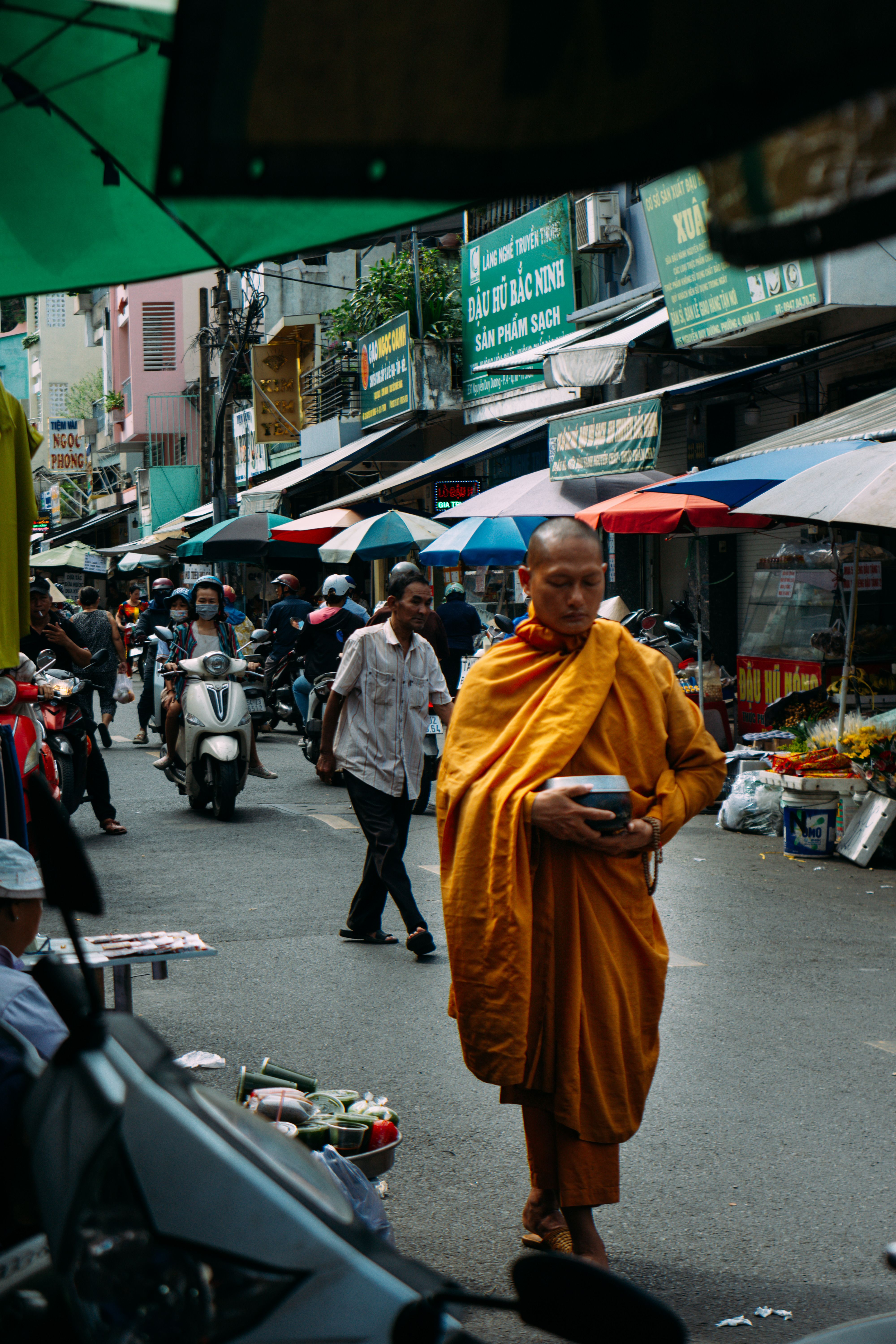 Monk Walking Through Busy Asian Market Street · Free Stock Photo