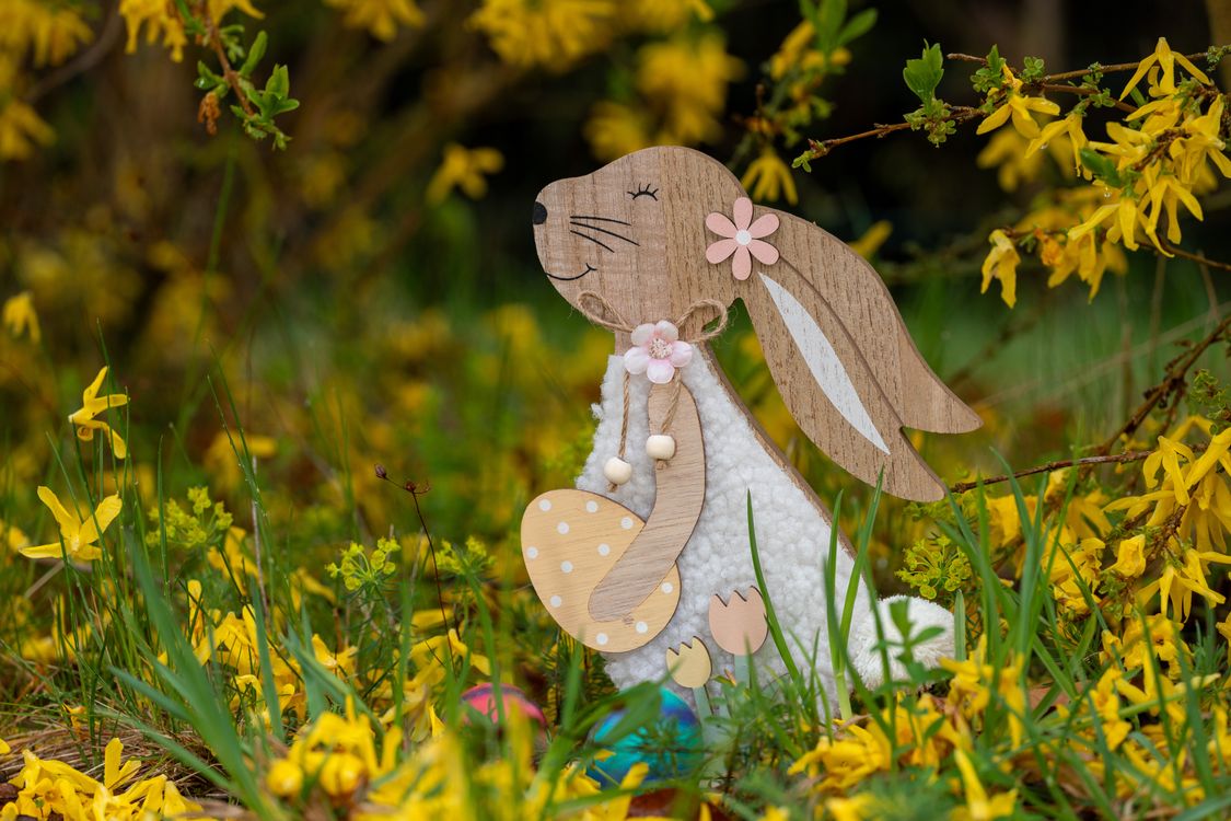 Wooden Easter Bunny in Spring Floral Garden · Free Stock Photo
