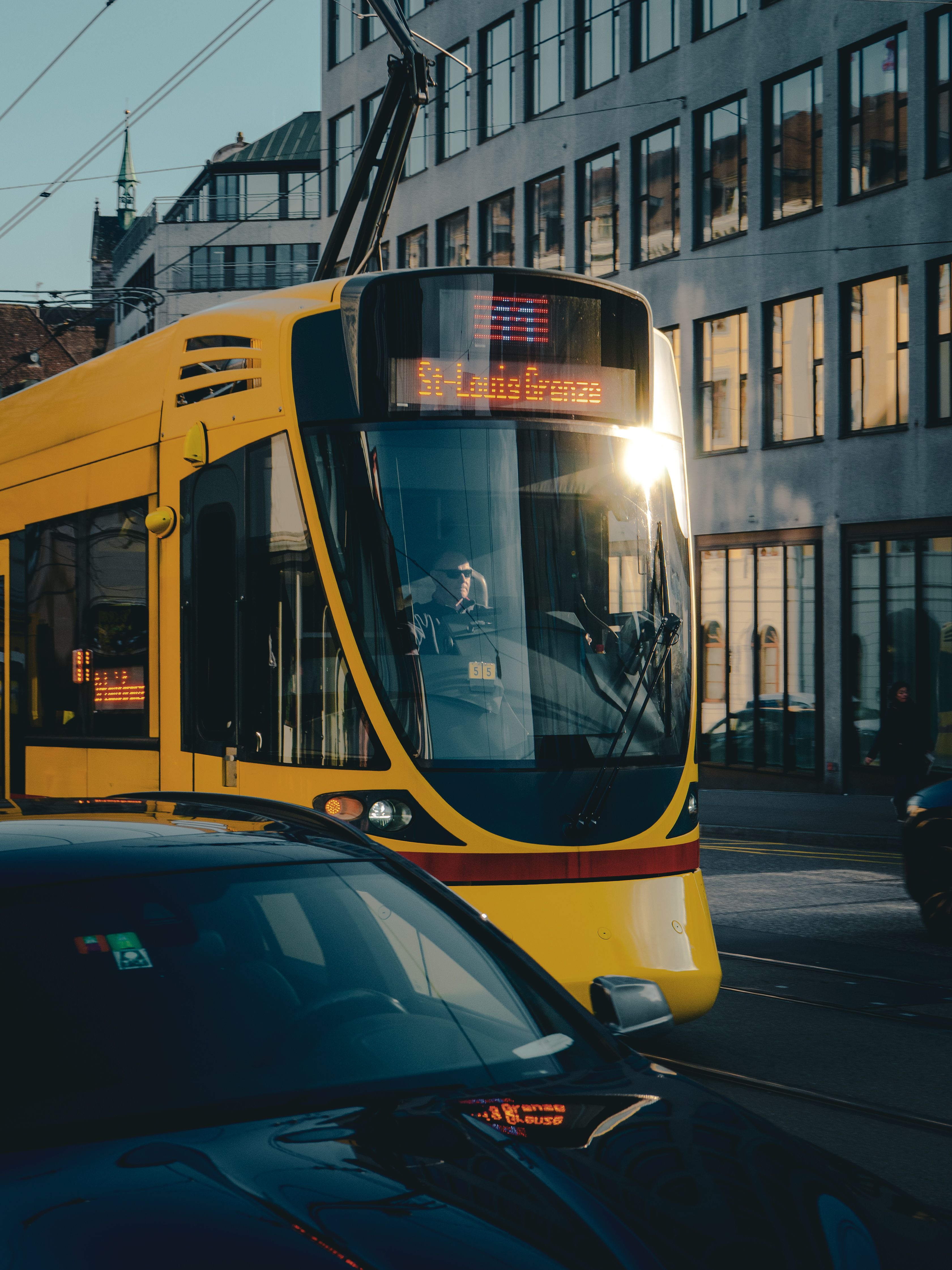 Yellow Tram Navigating Basel's Urban Streets · Free Stock Photo