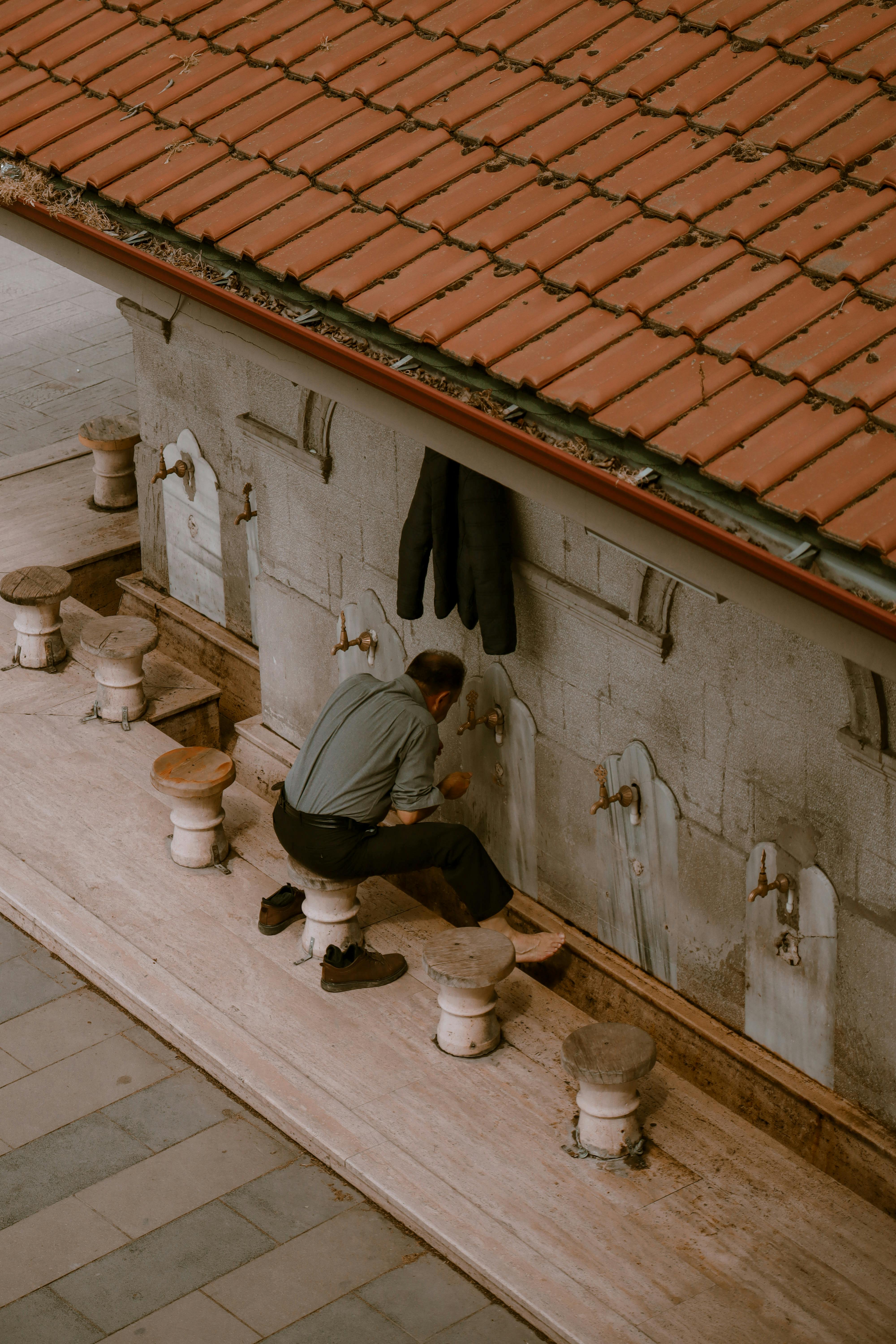 Man Performing Ritual Ablution in Outdoor Area · Free Stock Photo