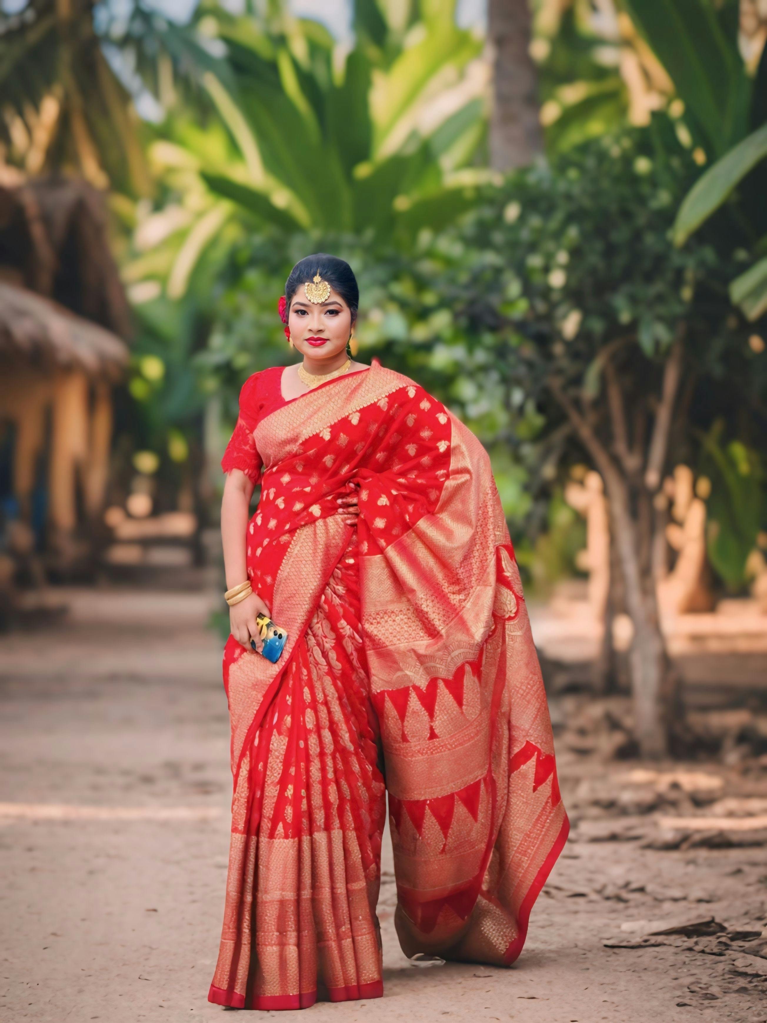 Elegant Woman in Red Saree Walking Outdoors · Free Stock Photo