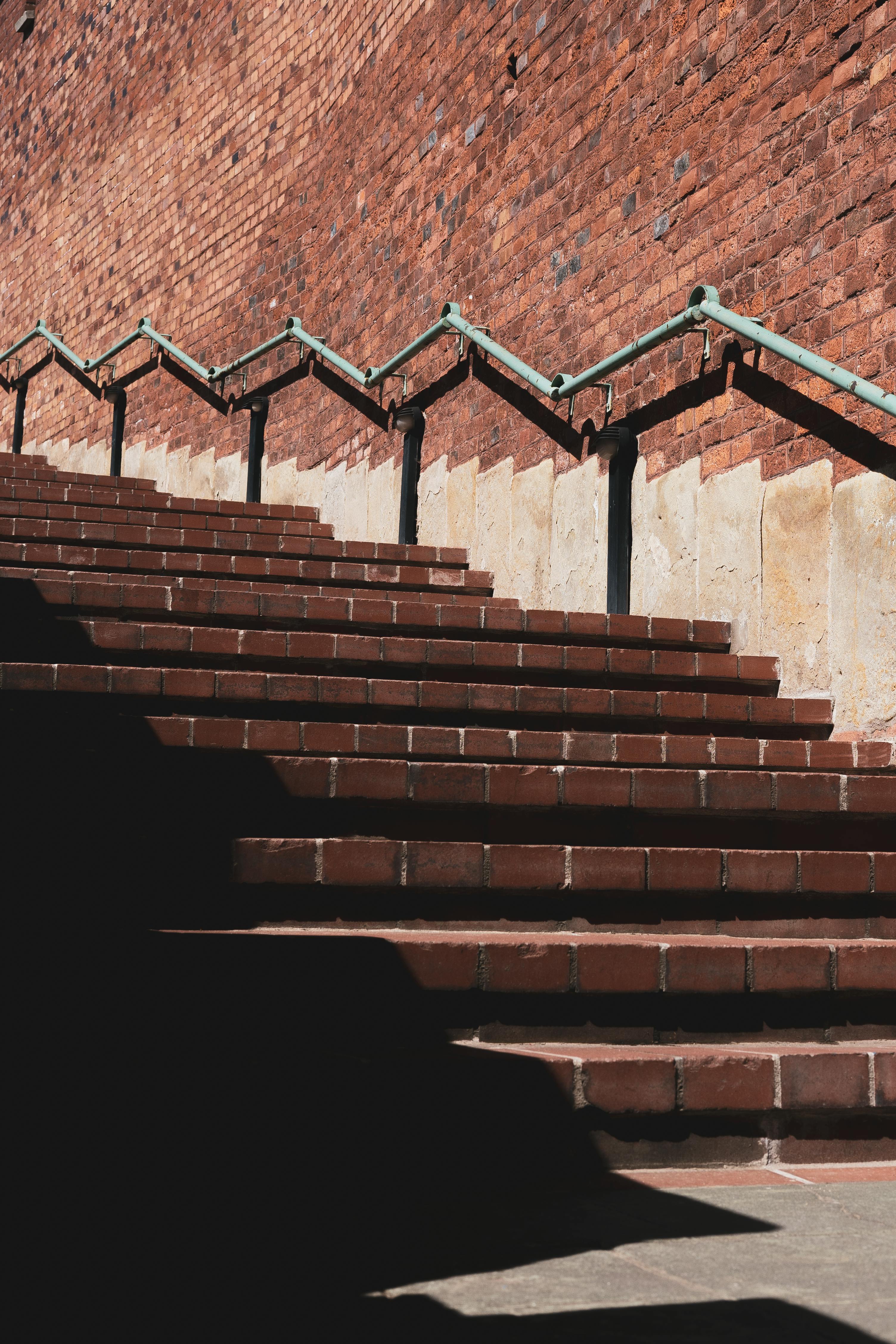 Red Brick Stairway with Patina Copper Railings · Free Stock Photo