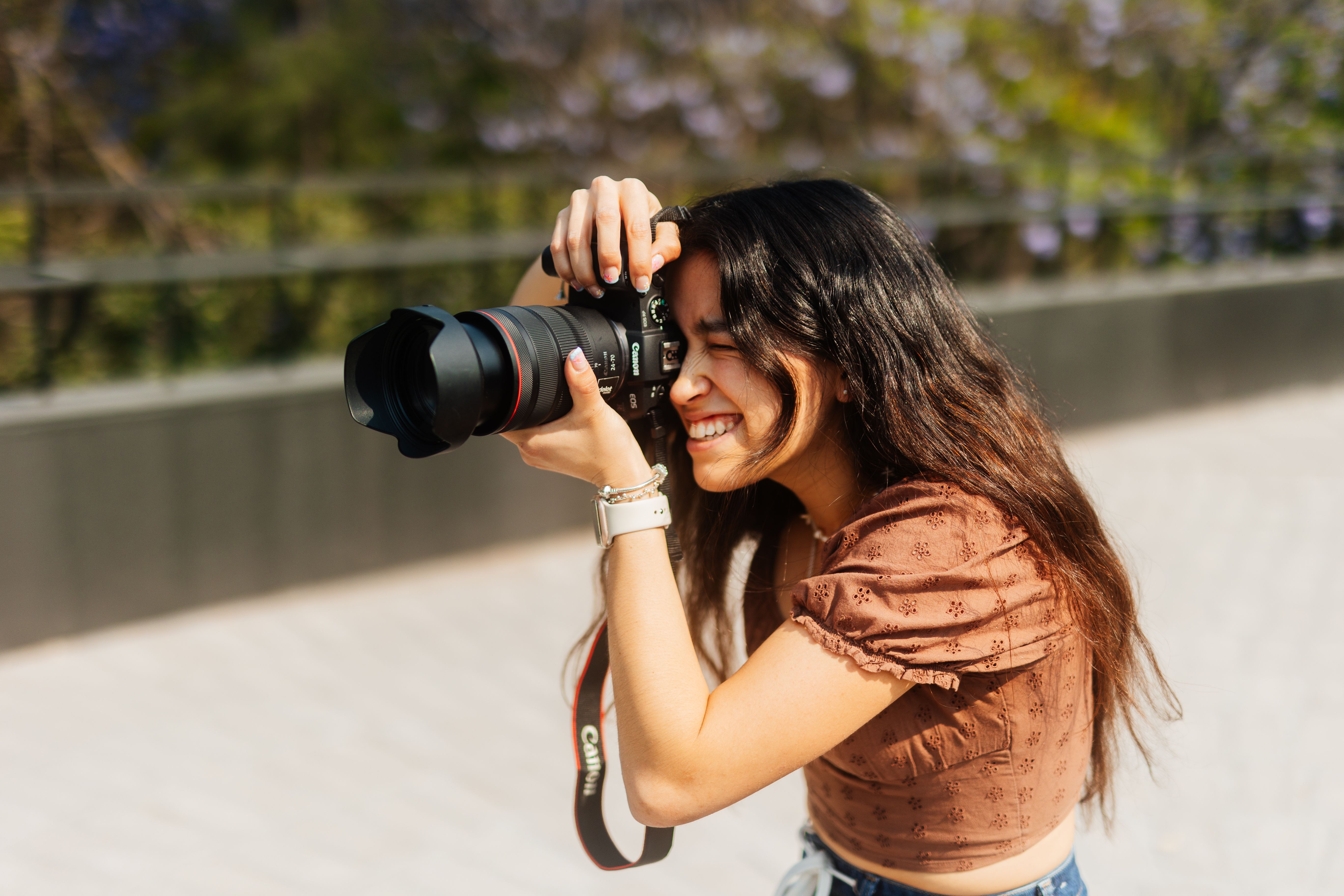 Young Photographer in Action Capturing Outdoors · Free Stock Photo