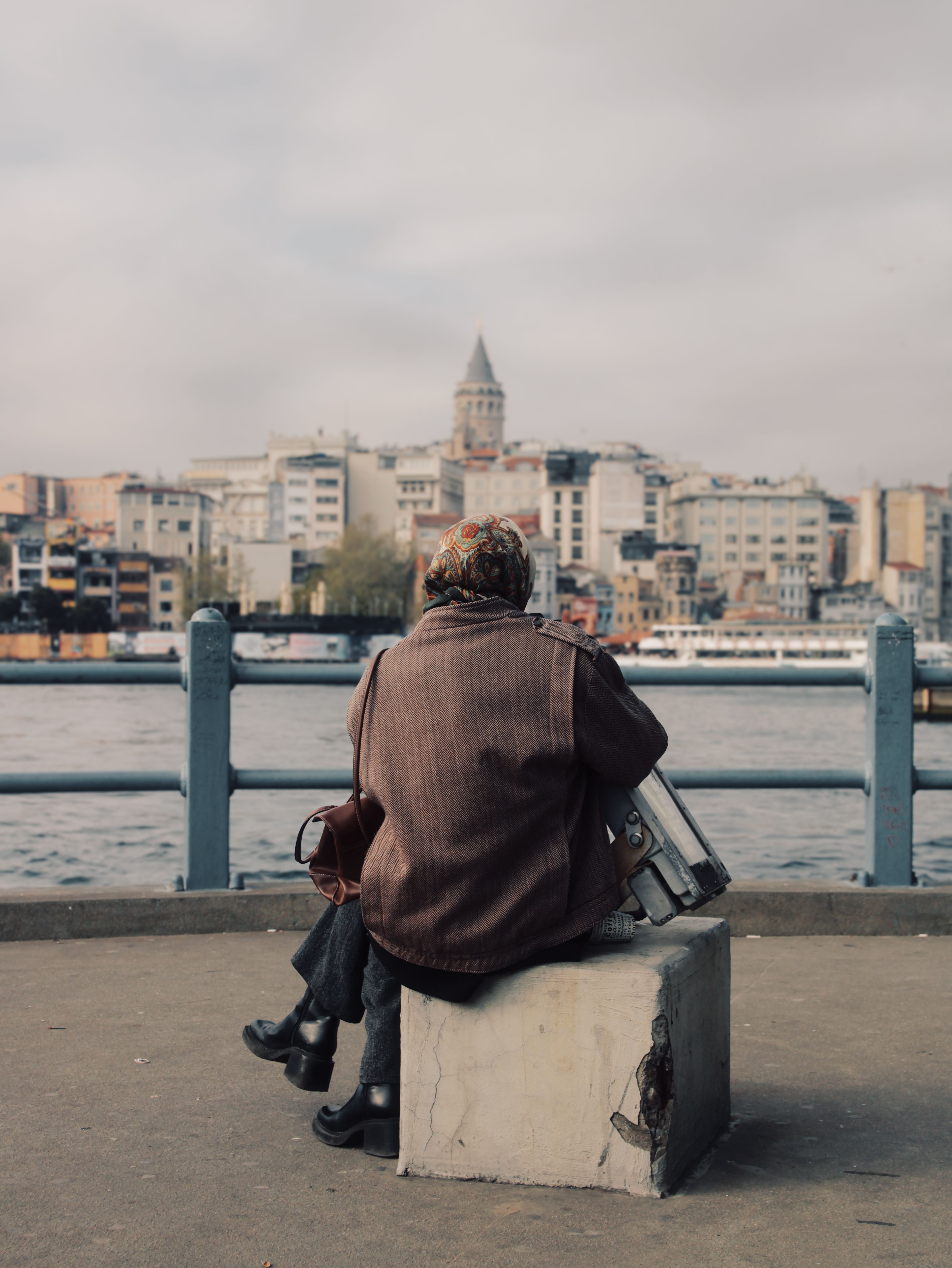Person Sitting by Galata Tower in Istanbul · Free Stock Photo