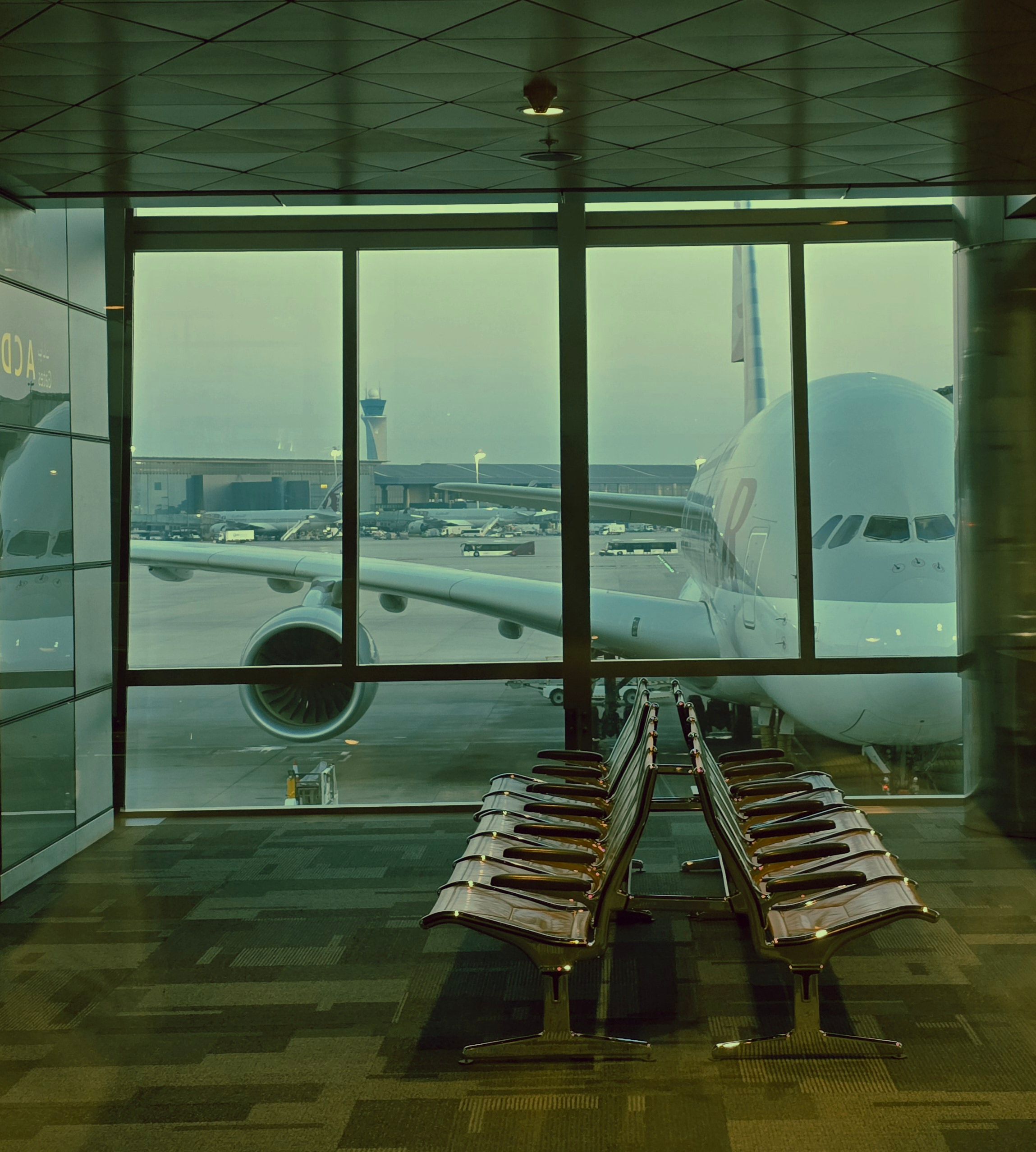 Airplane view from airport terminal window · Free Stock Photo