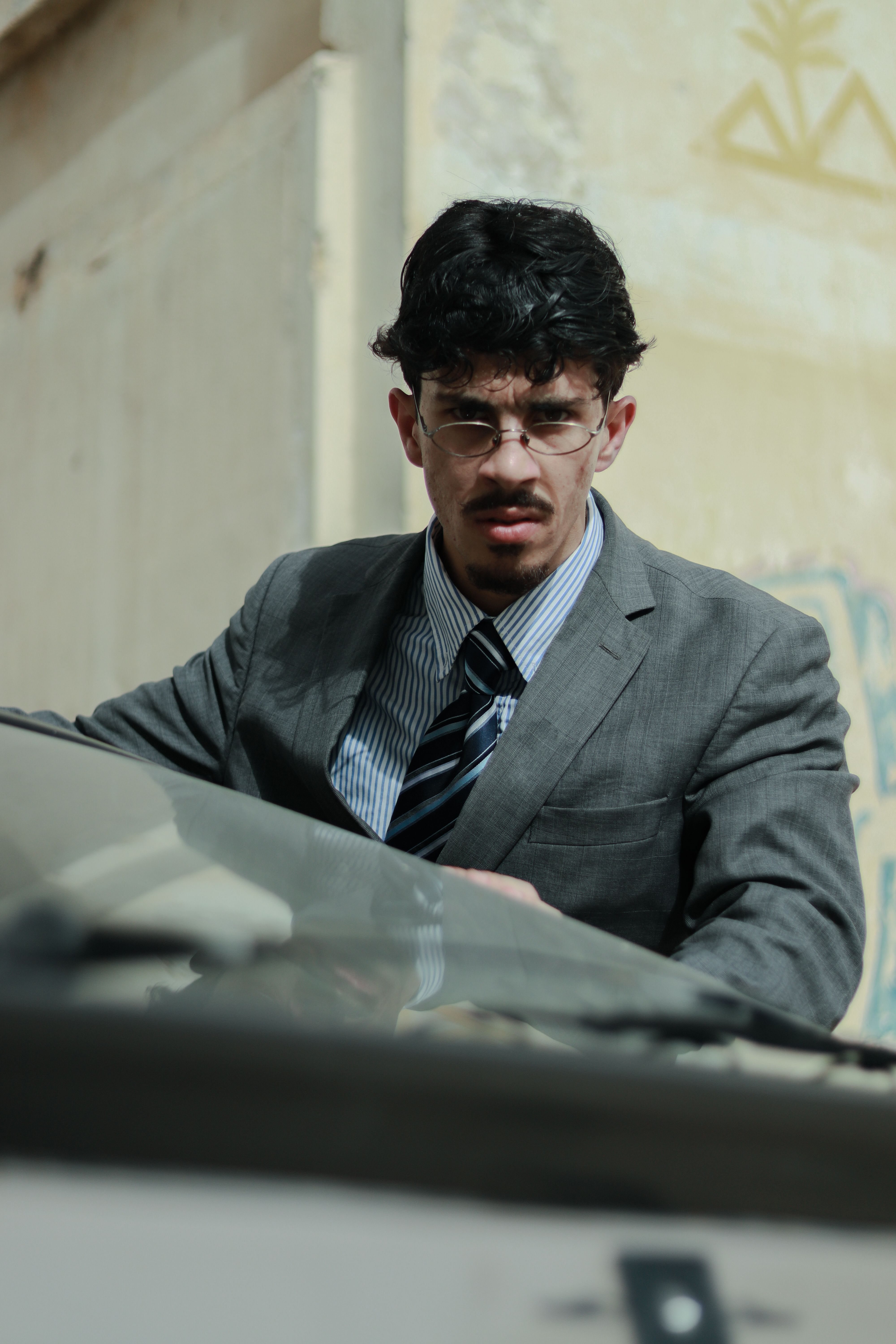Businessman in Suit Outdoors Near Industrial Building · Free Stock Photo