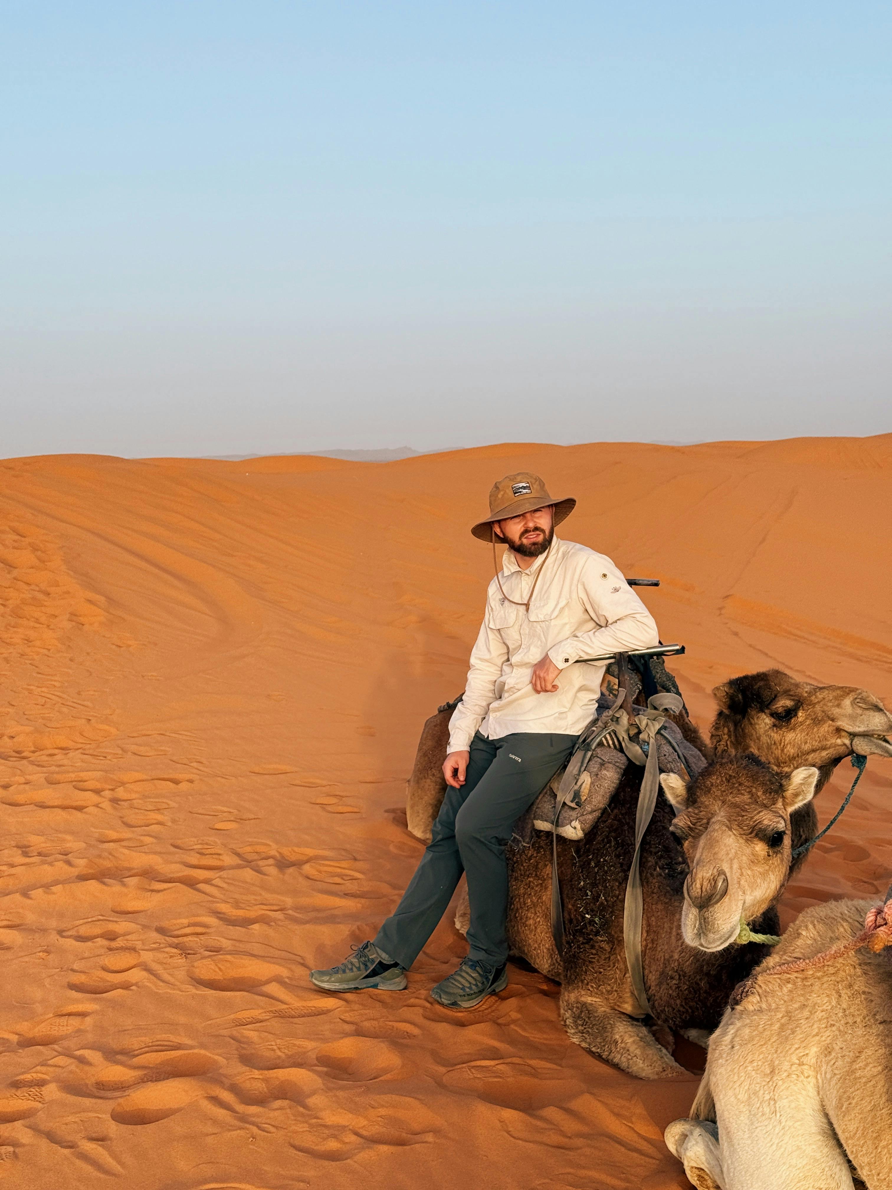 Human Riding Camel on Dessert Under White Sky during Daytime · Free ...
