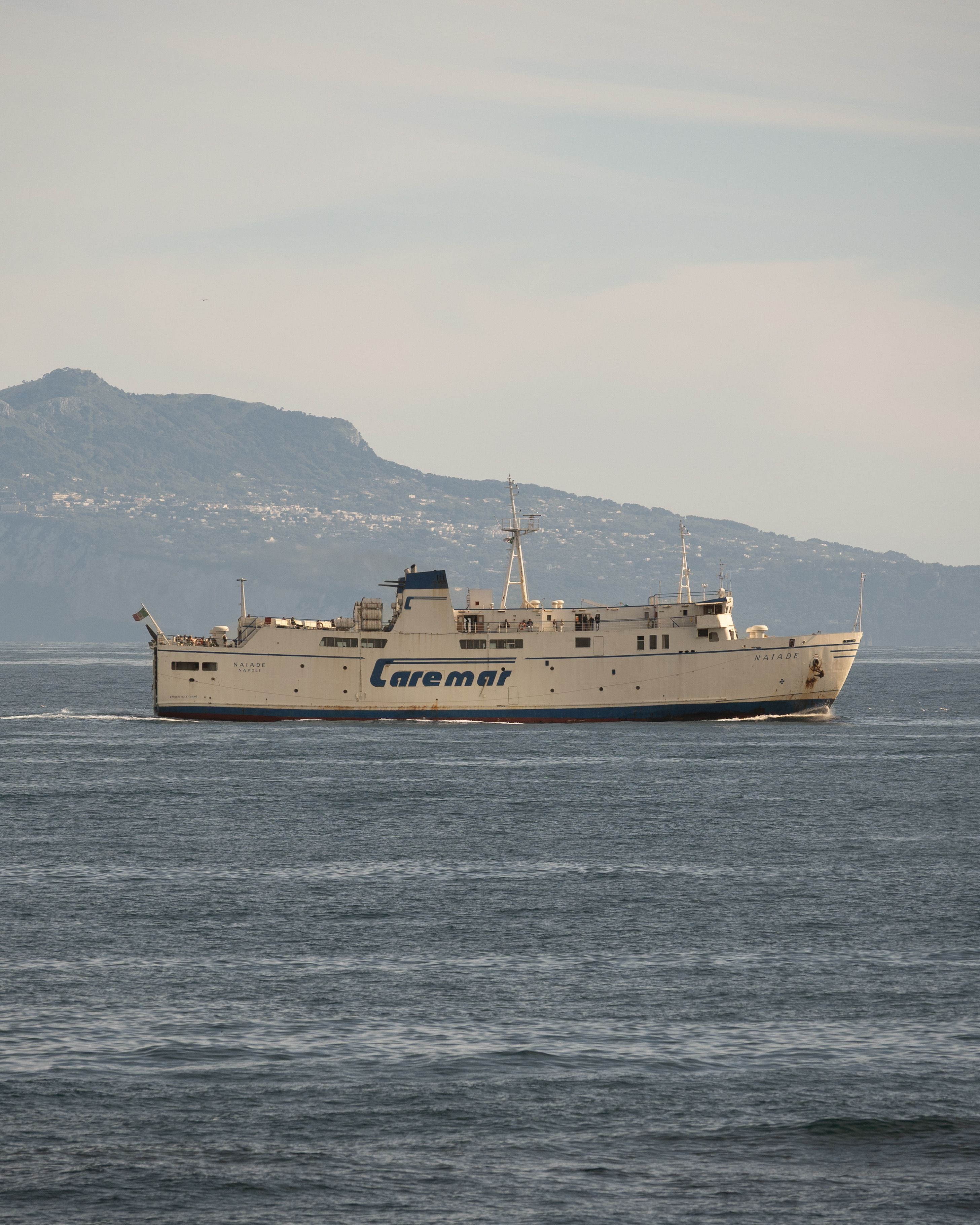 Passenger Ferry on the Sea with Mountainous Backdrop · Free Stock Photo