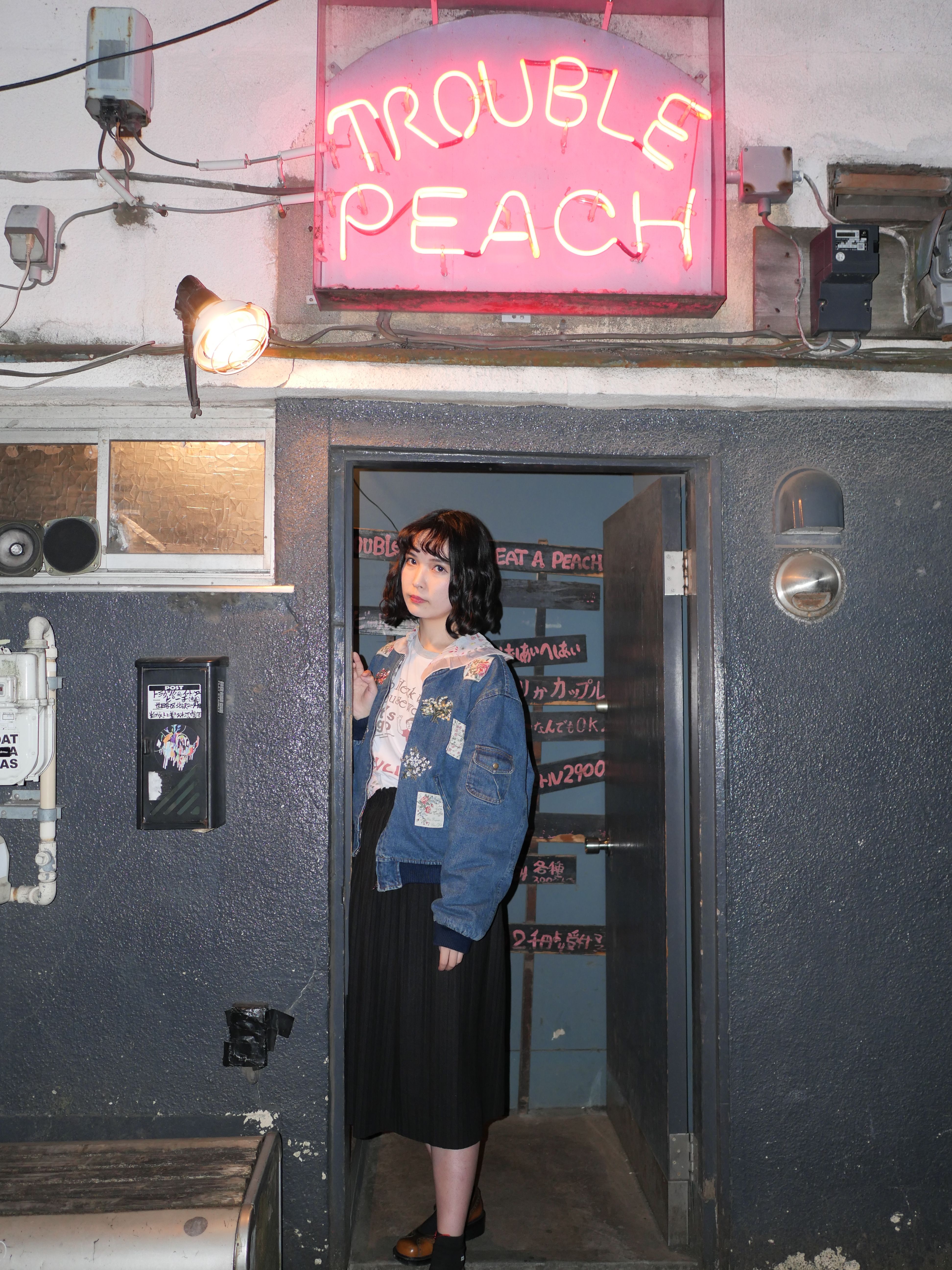 Young Woman Standing Under Neon Sign at Night · Free Stock Photo