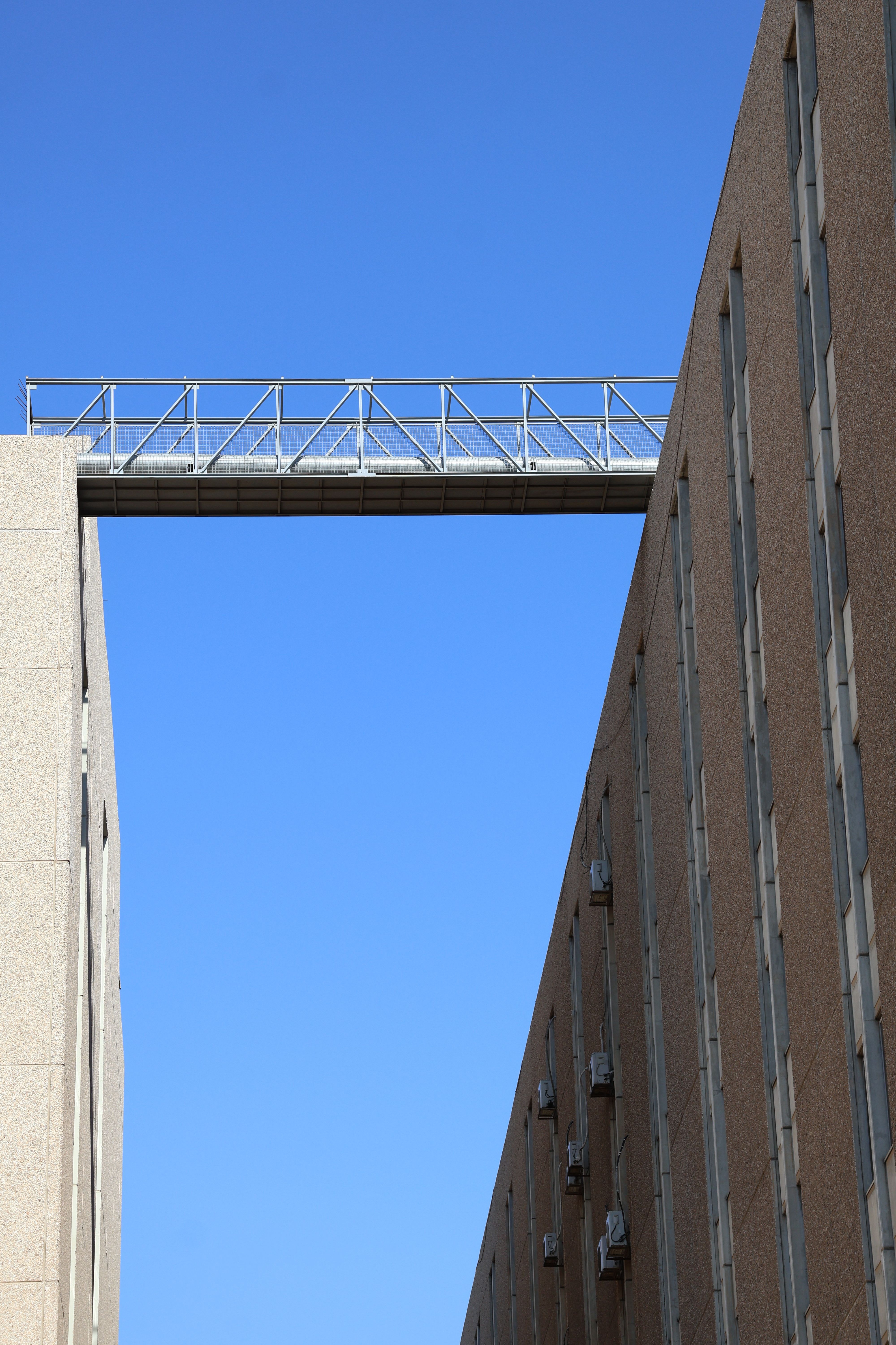 Minimalist Bridge Between Two Concrete Buildings · Free Stock Photo