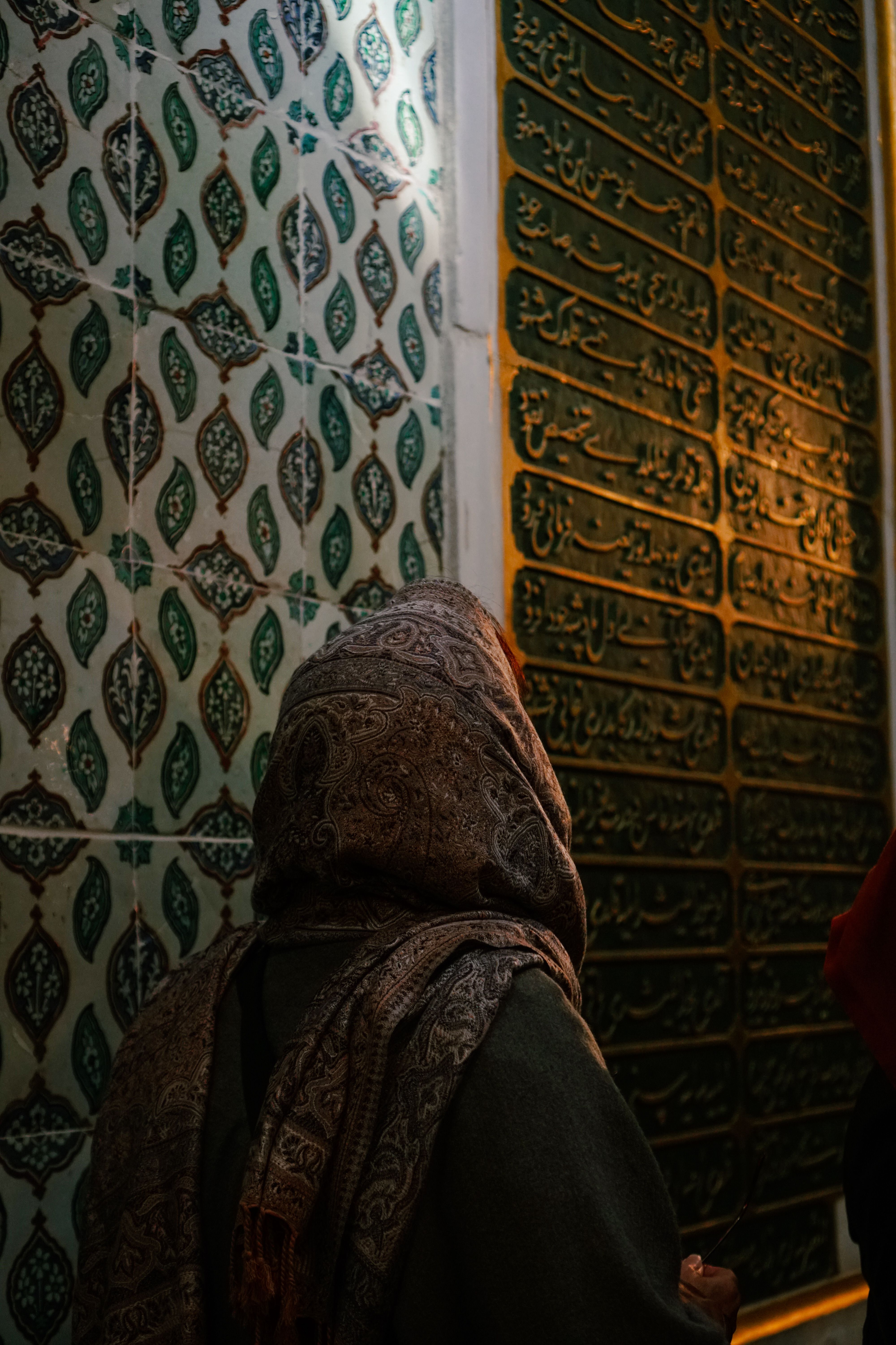 Mysterious Person Near Ornate Middle Eastern Wall · Free Stock Photo