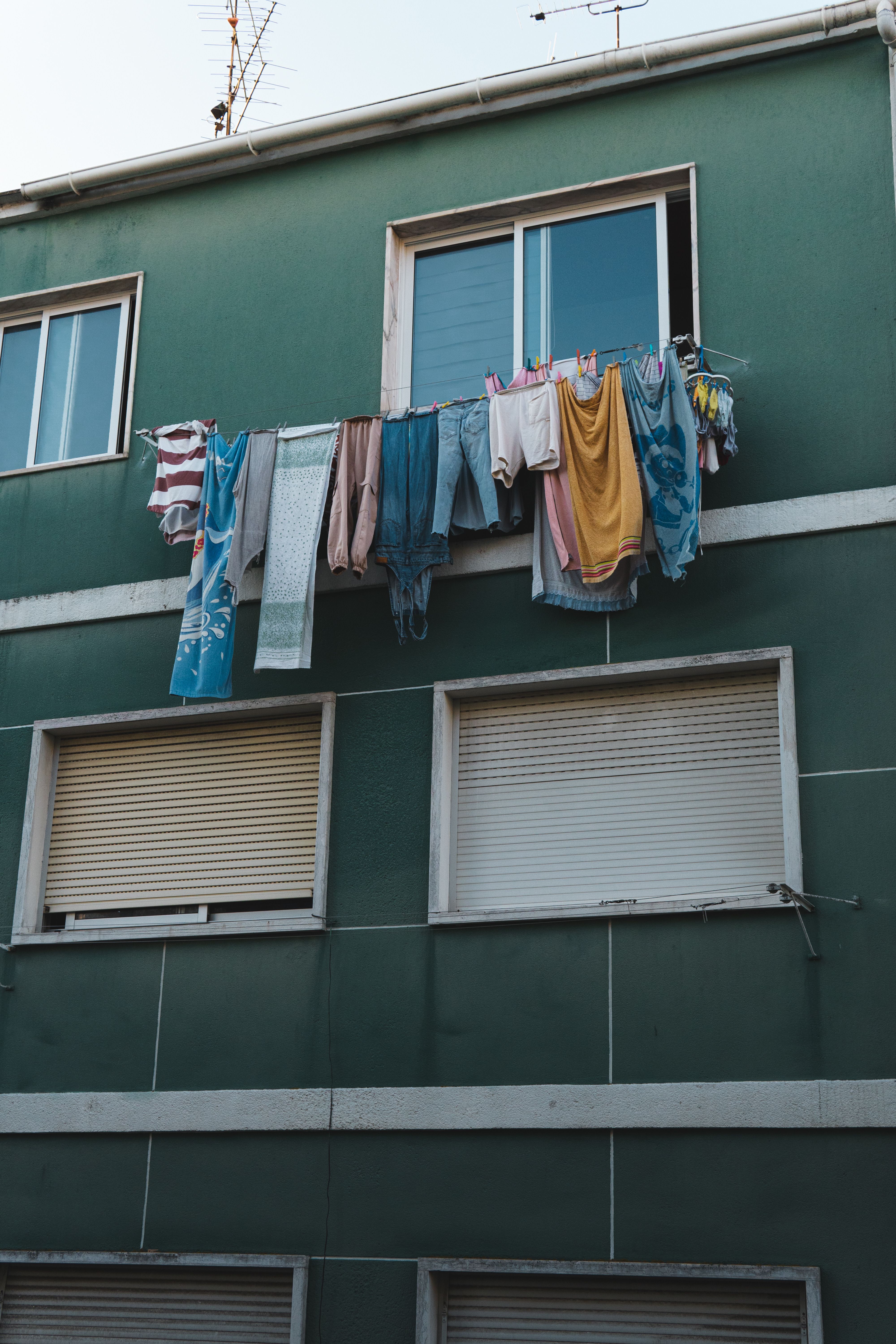 Low Angle View of Clothes Hanging on Balcony · Free Stock Photo
