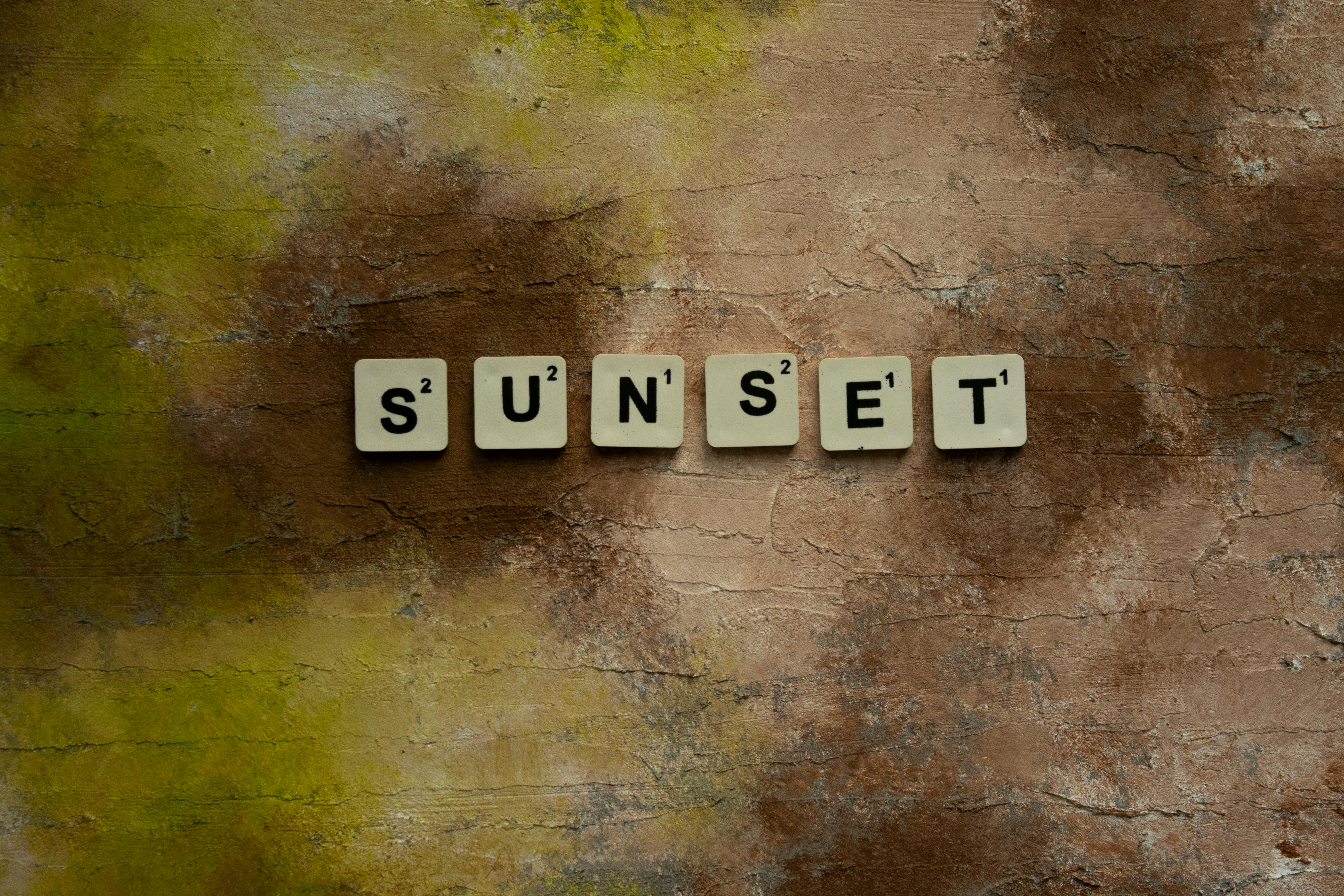 Scrabble Tiles Forming the Word Sunset on Textured Background · Free ...