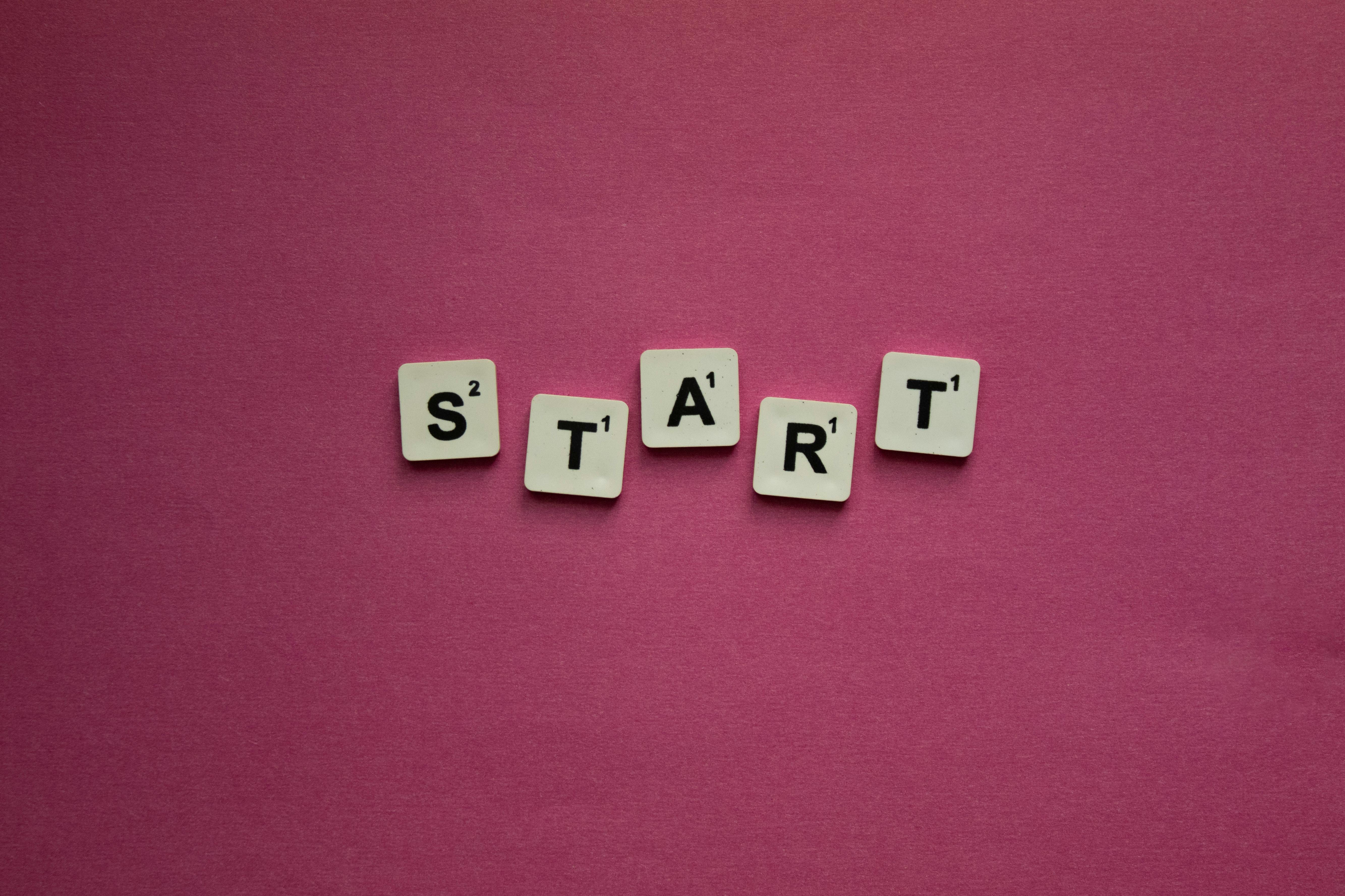 Scrabble Tiles Forming WORD Start on Pink Background · Free Stock Photo