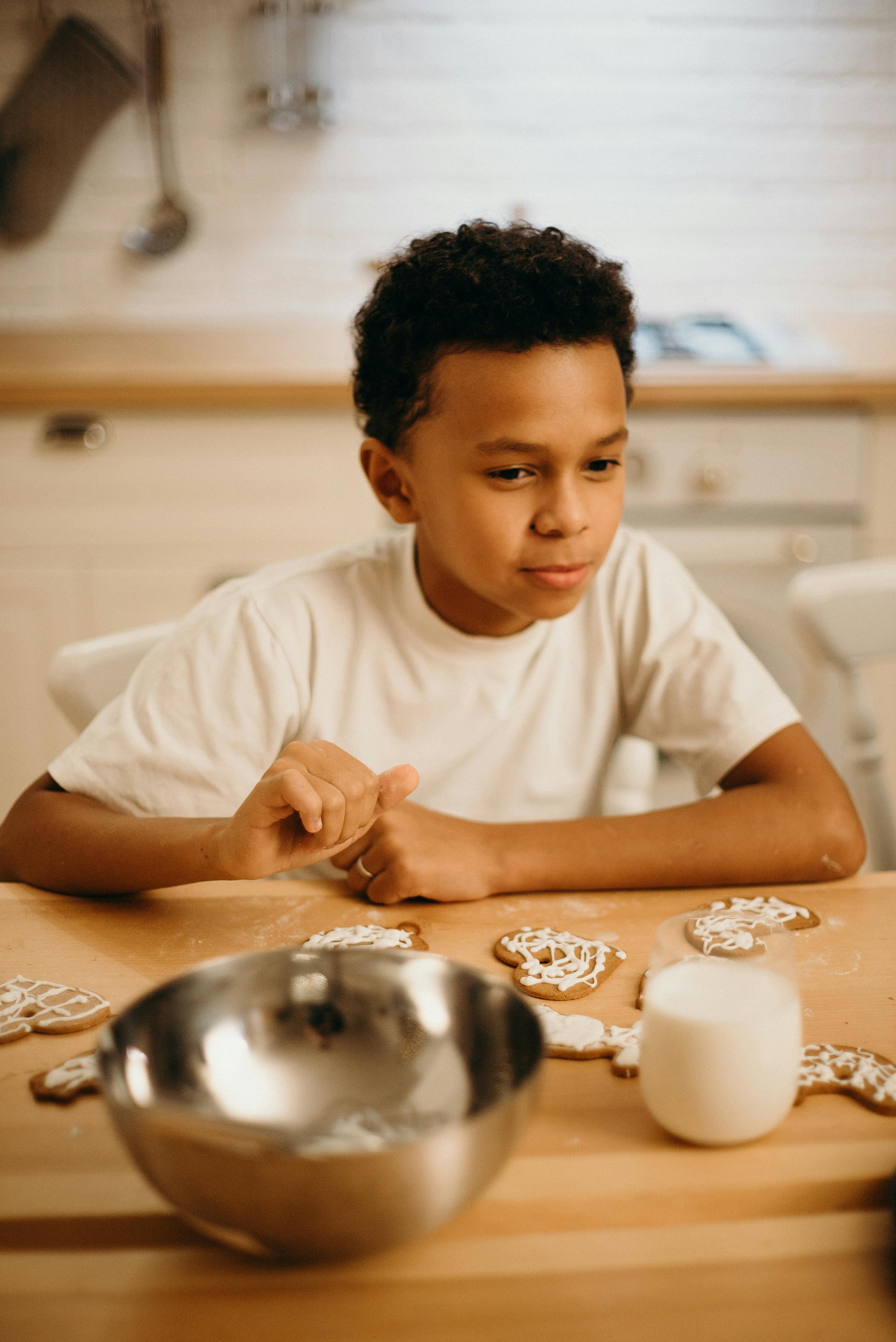 Selective Focus Photography of Boy Beside Table With Cookies · Free ...