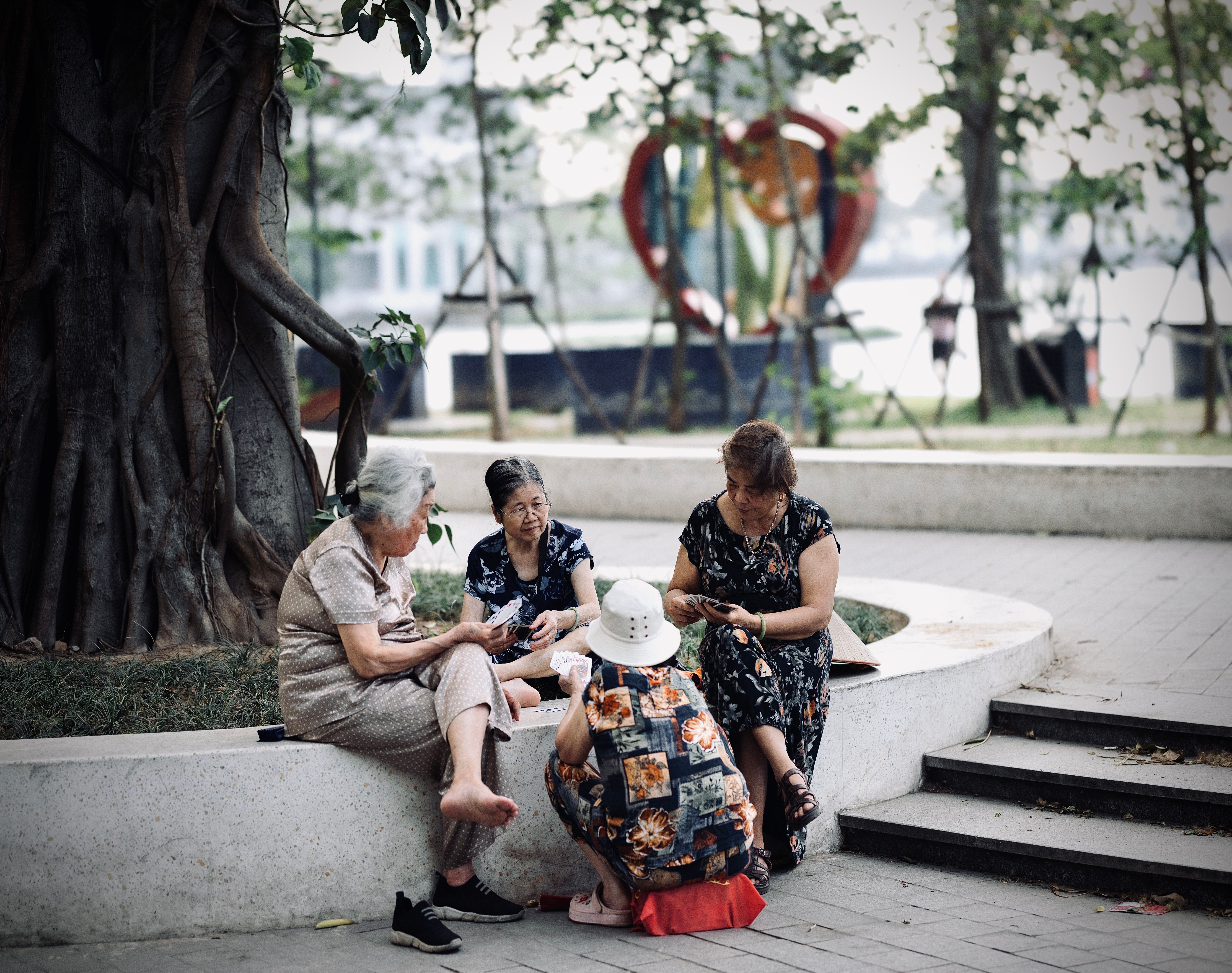 Elderly Women Socializing in Urban Park · Free Stock Photo