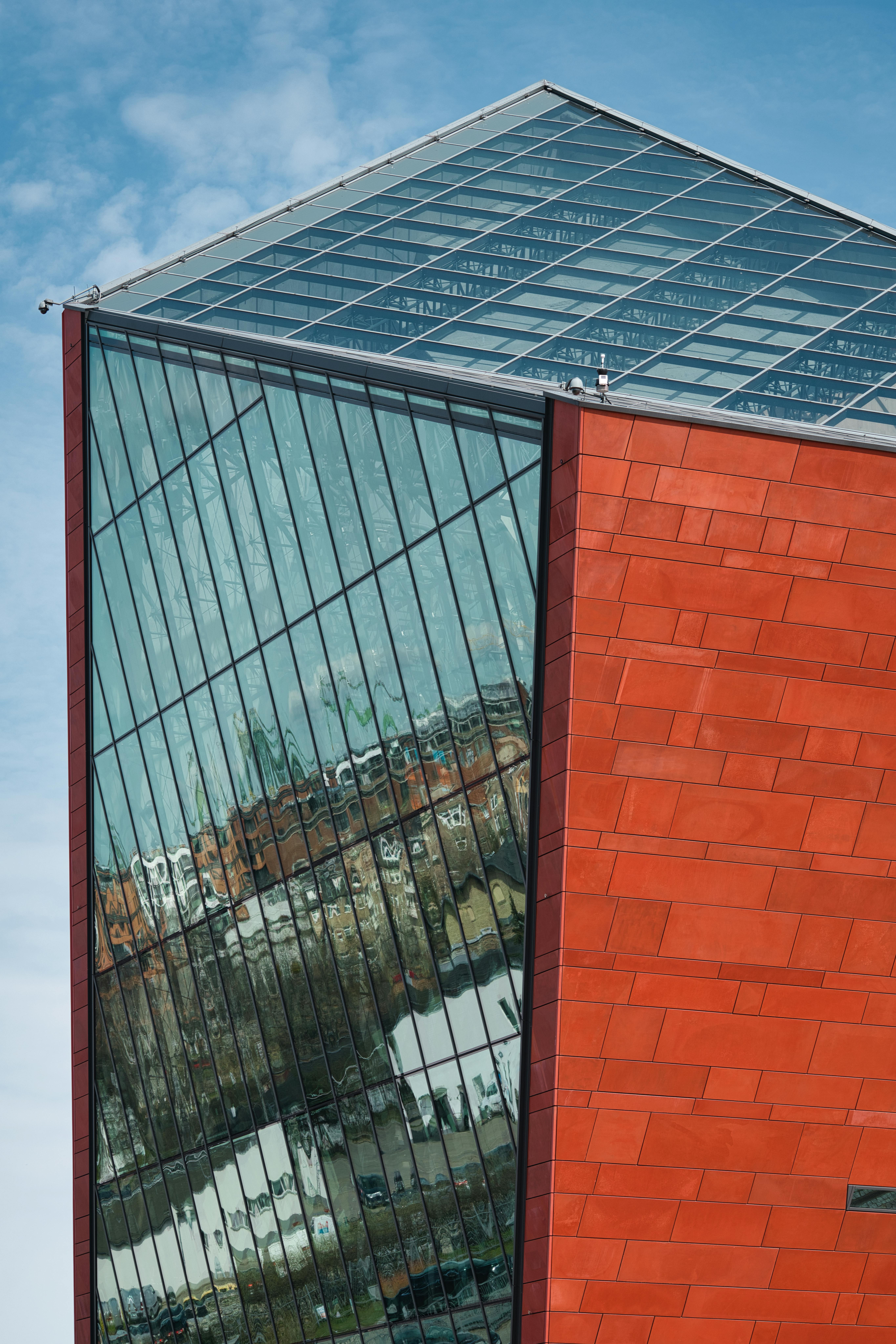Modern Red Architecture with Reflective Glass Facade · Free Stock Photo