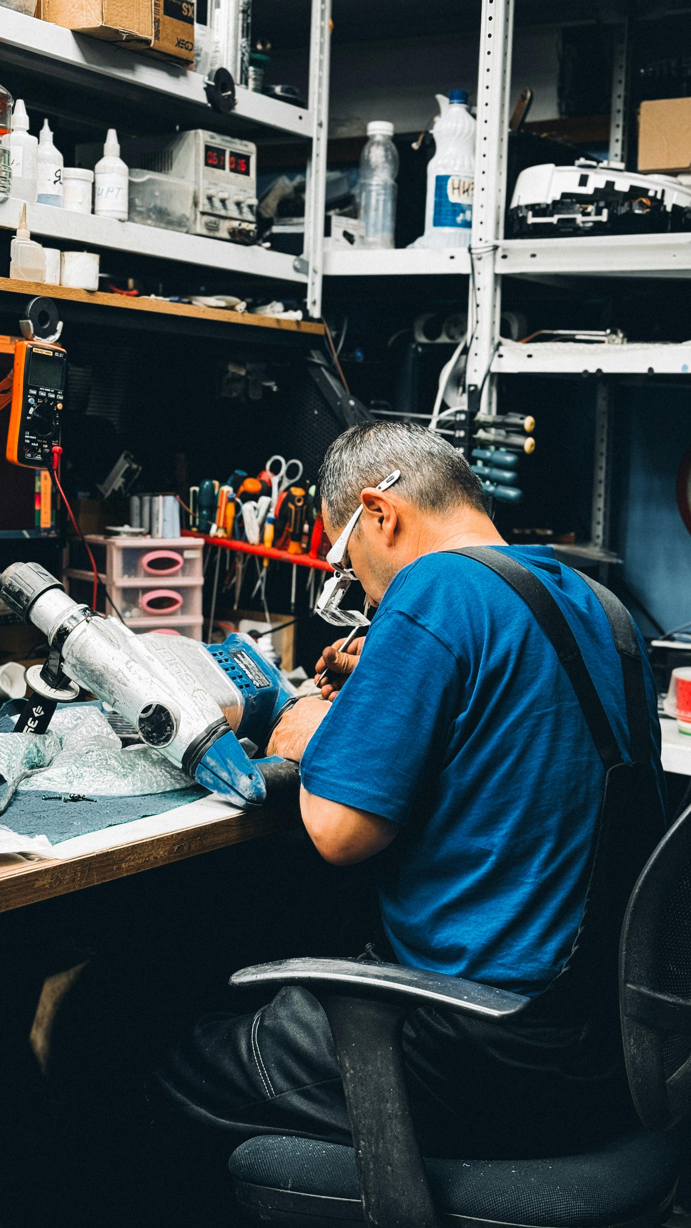 Skilled Technician Repairing Device in Workshop · Free Stock Photo