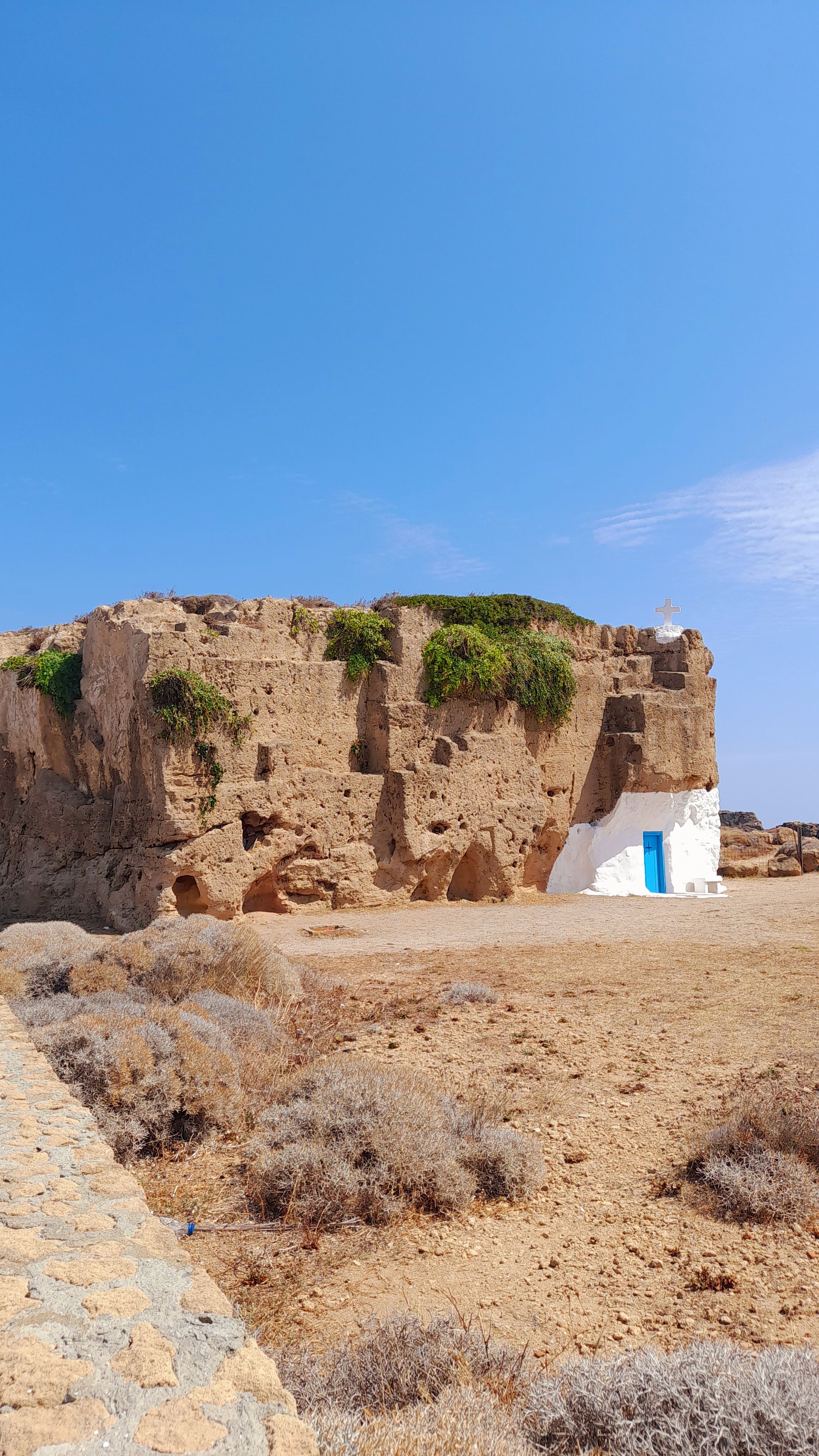 Scenic Coastal Cliff with White Structure under Blue Sky · Free Stock Photo