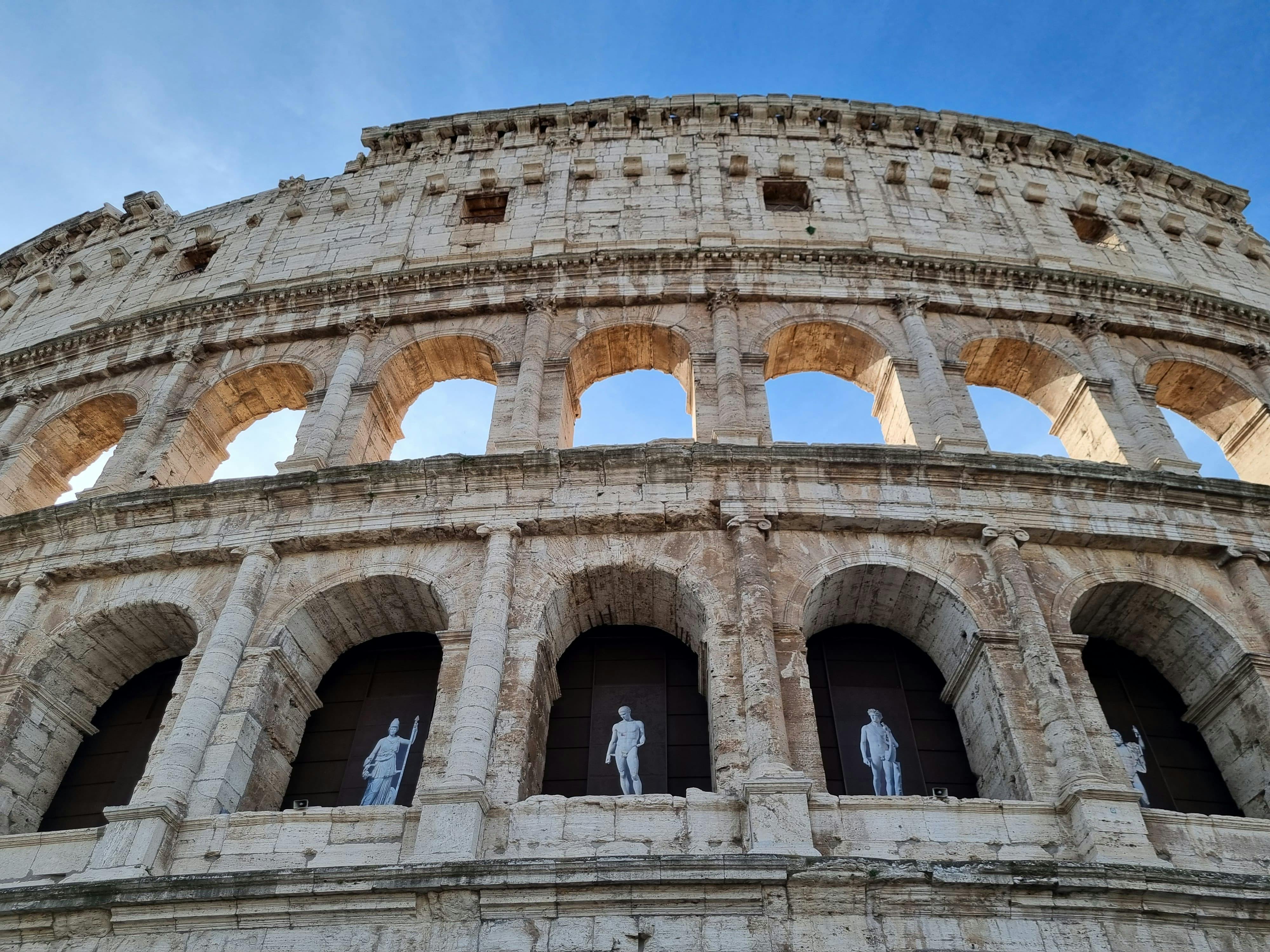 Colosseum Exterior with Historical Figures · Free Stock Photo