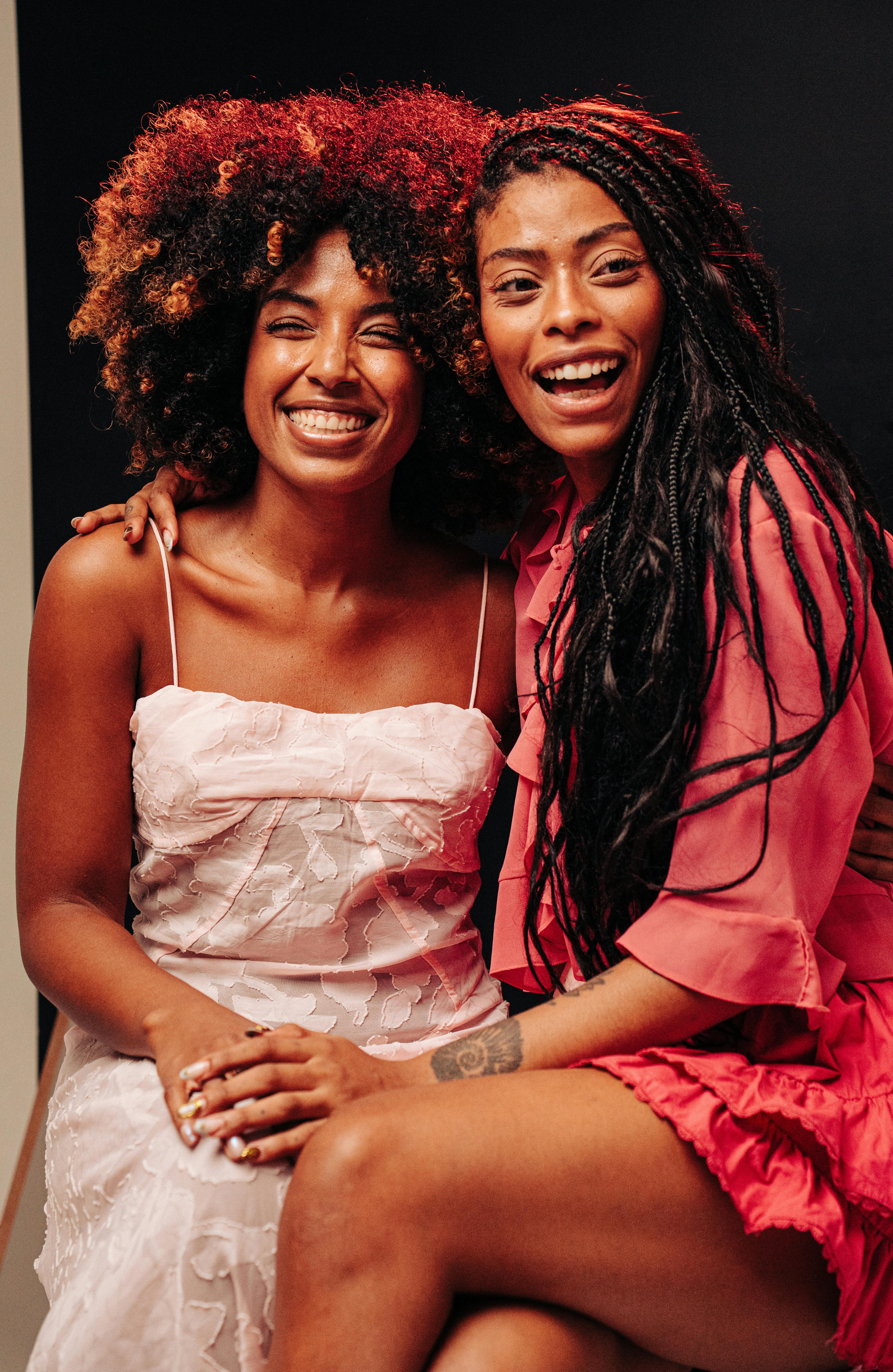 Joyful Portrait of Two Friends with Diverse Hairstyles · Free Stock Photo