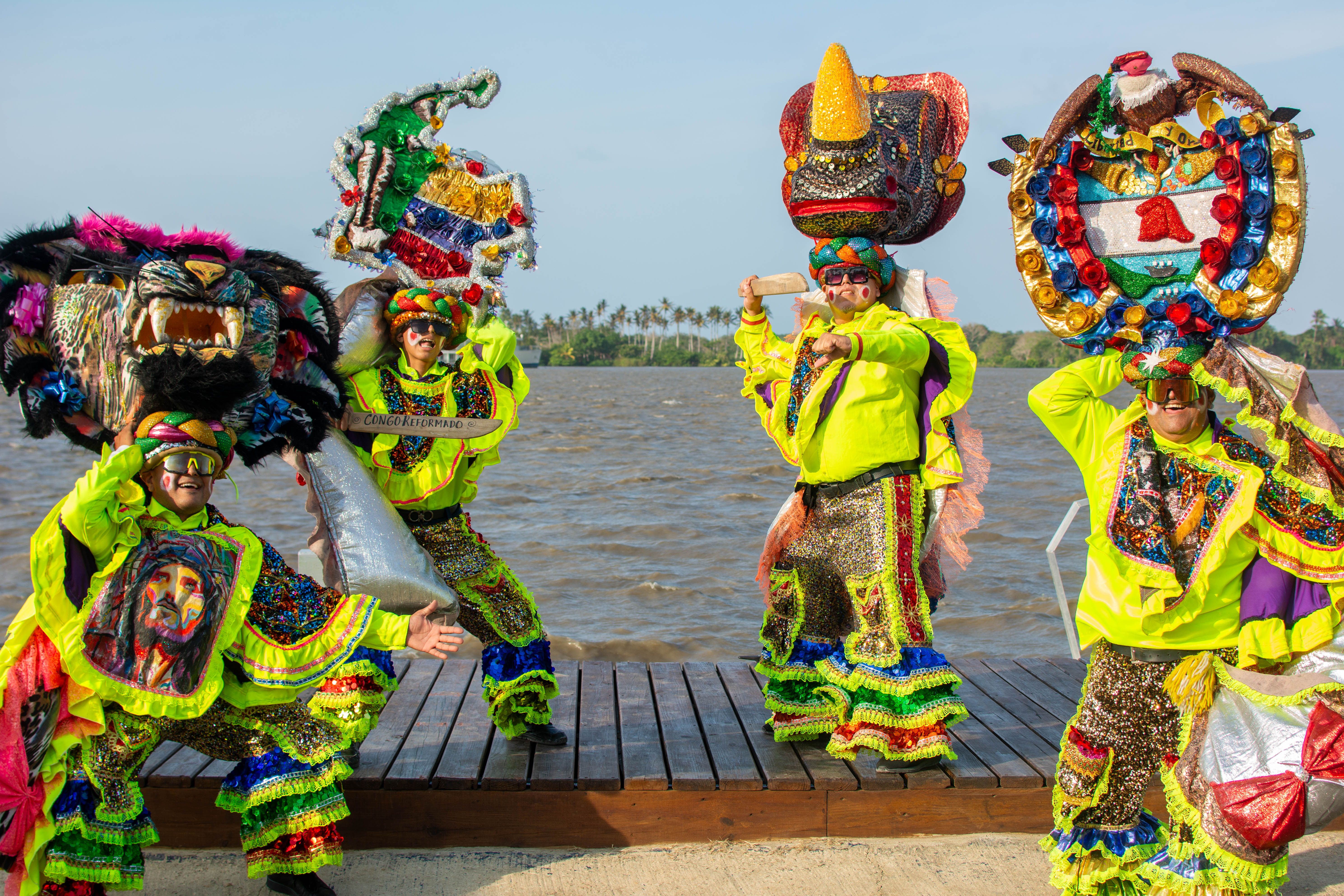 Vibrant Traditional Dance on Riverside Pier · Free Stock Photo