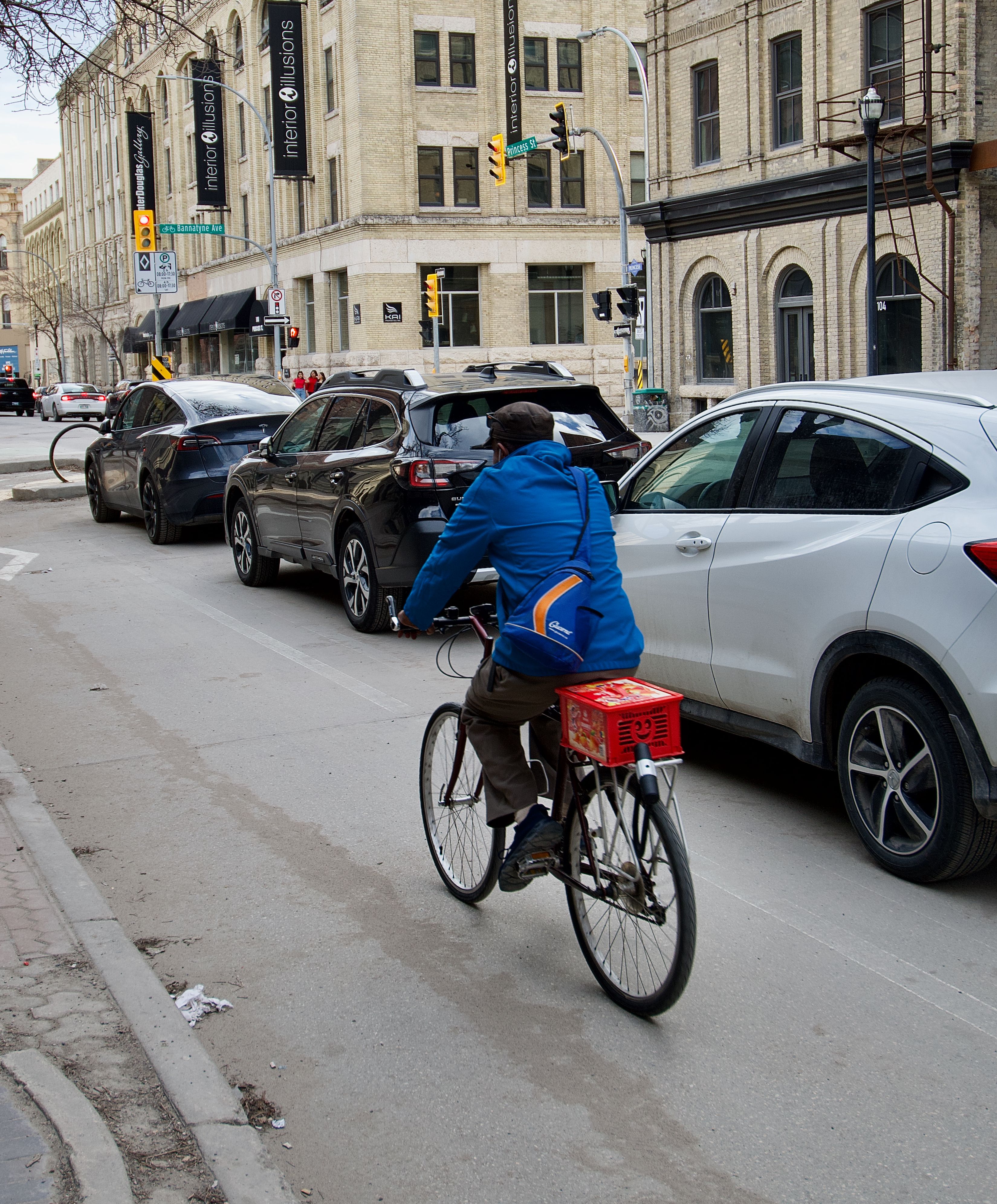 Cyclist navigating downtown Winnipeg street traffic · Free Stock Photo