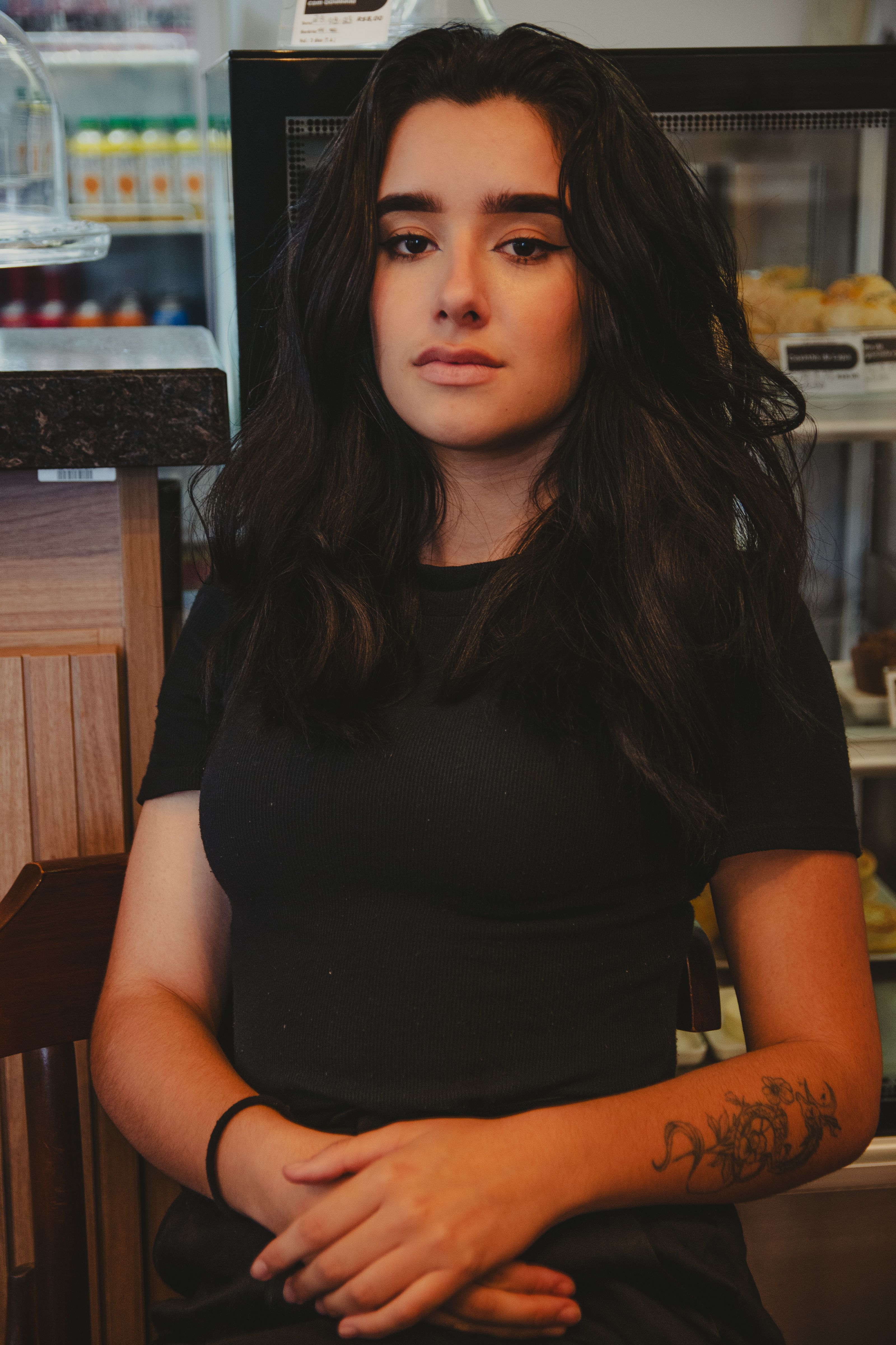 Portrait of a Young Woman in a Cafe Setting · Free Stock Photo