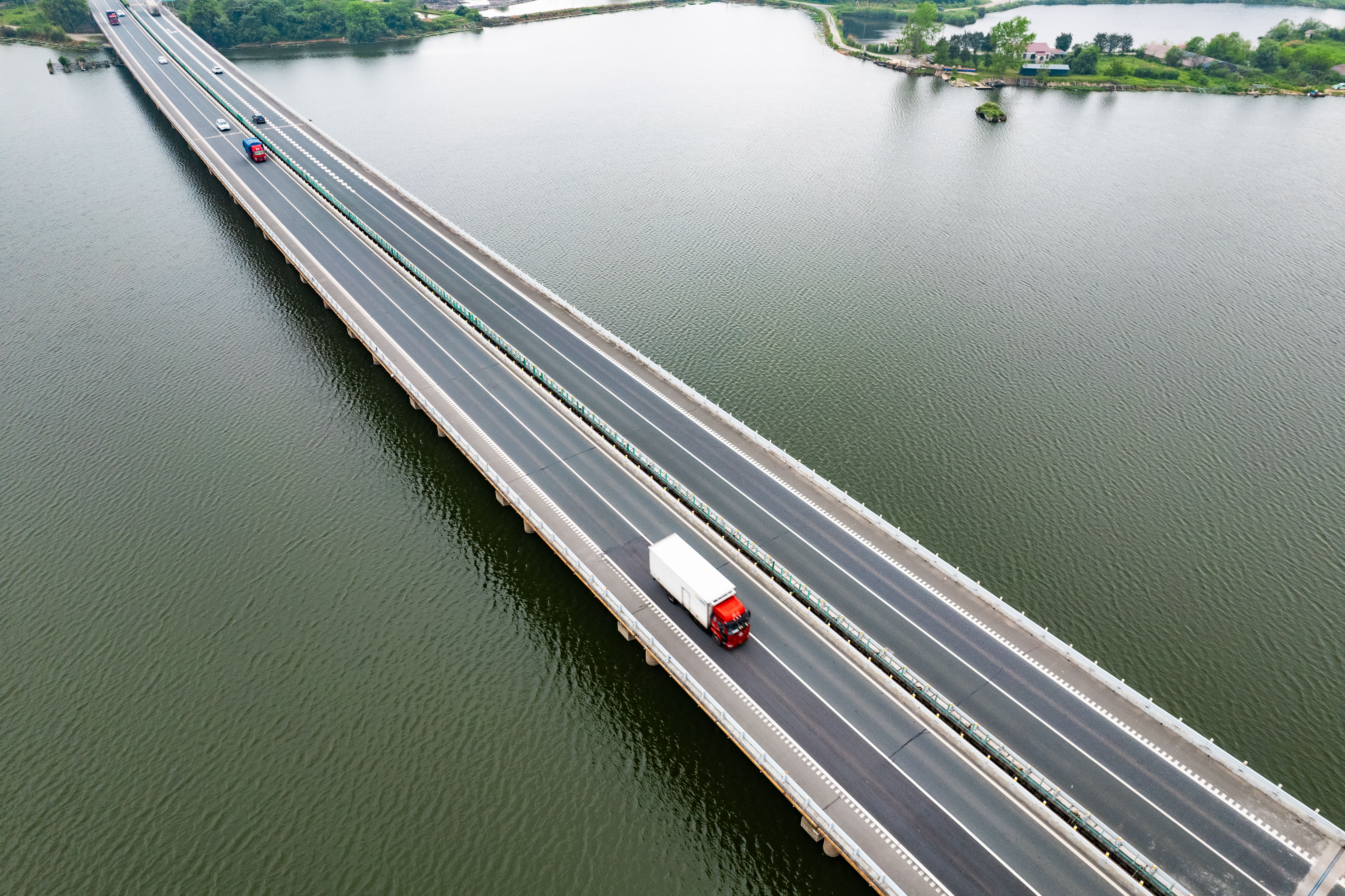 Aerial View of a Bridge Over Water with Vehicles · Free Stock Photo