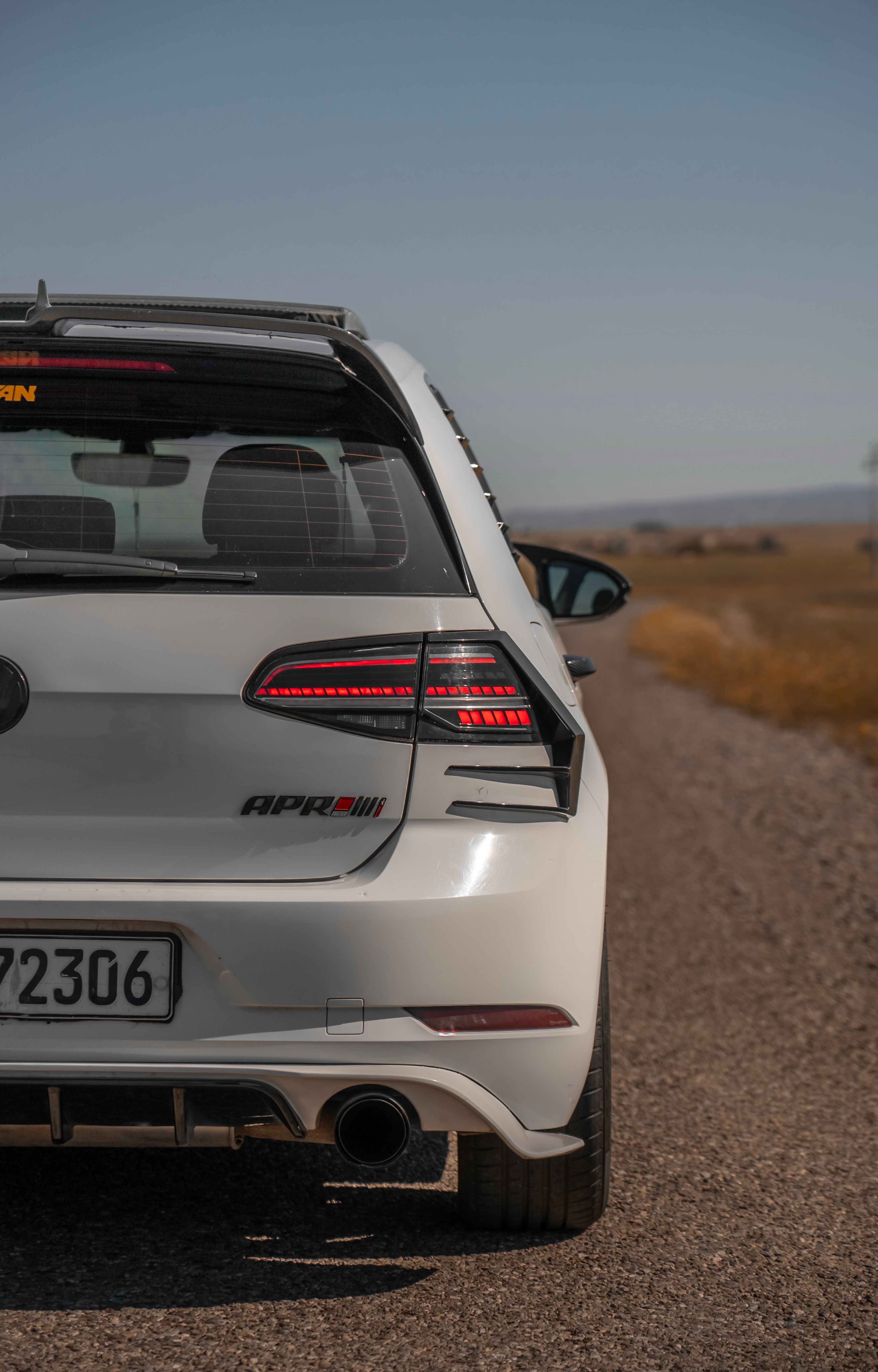 Rear View of Volkswagen Golf R on Open Road · Free Stock Photo