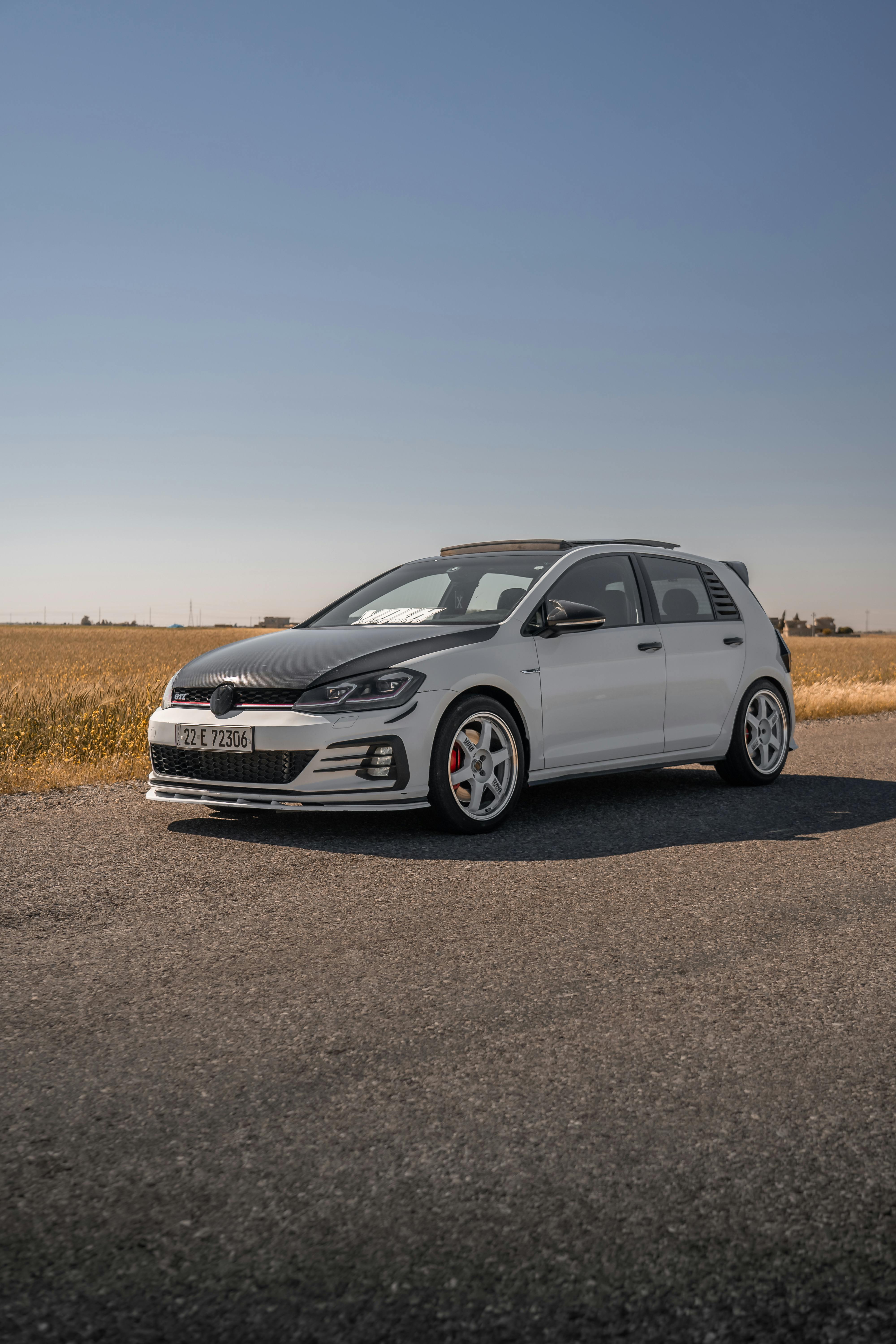 Volkswagen Golf R Sports Car in Open Field · Free Stock Photo