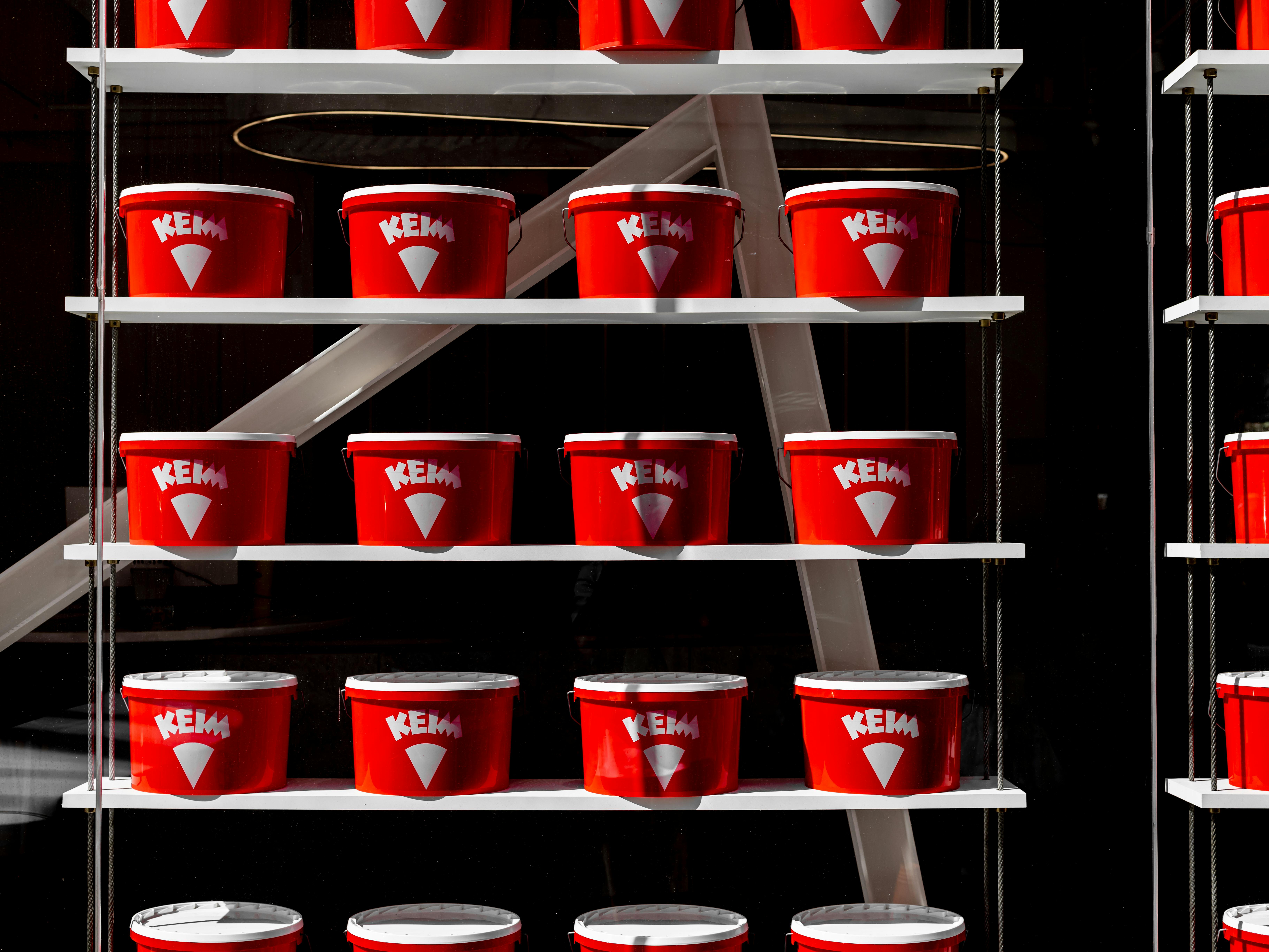 Red Paint Buckets Displayed in a Modern Storefront · Free Stock Photo