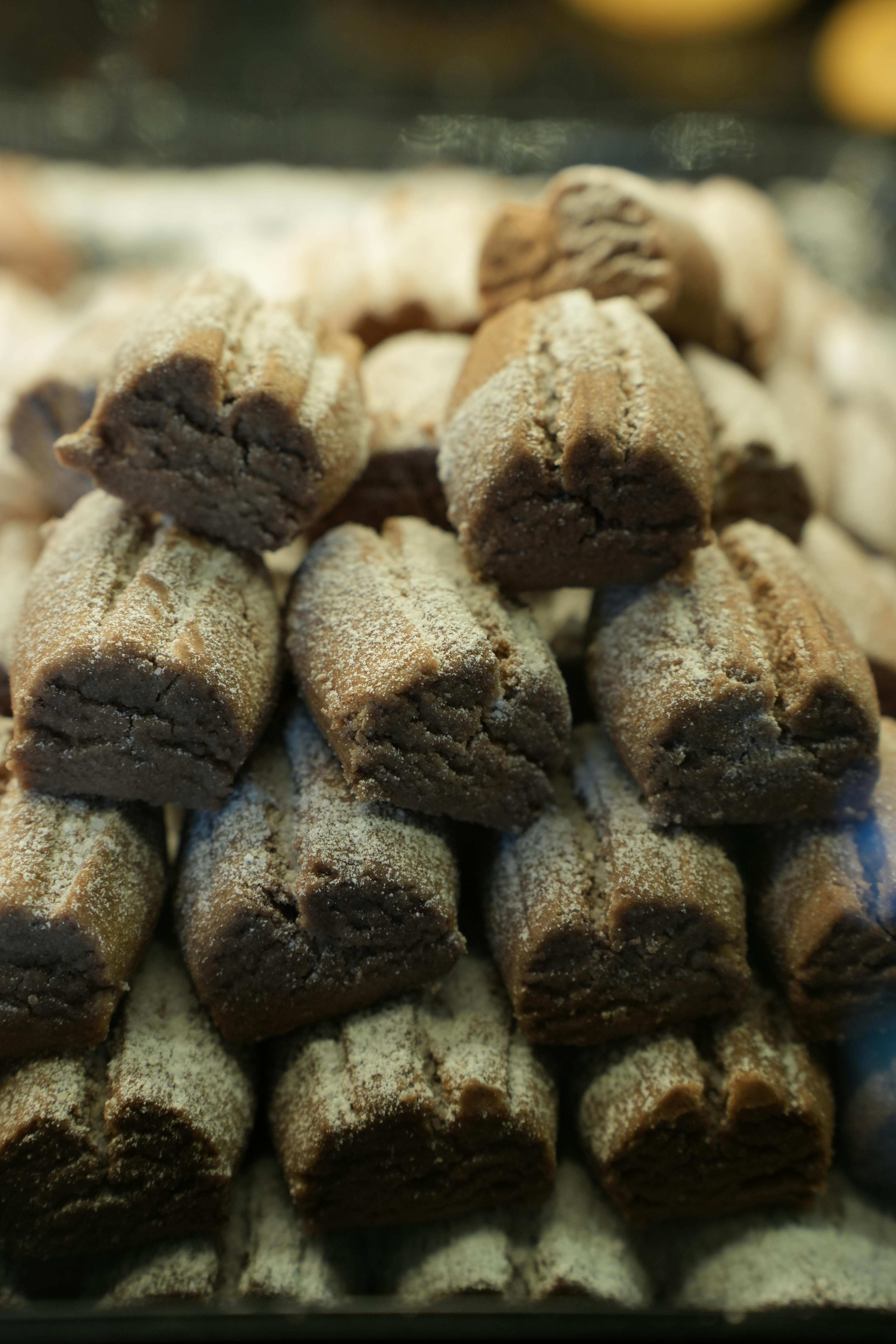 Stack of chocolate pastries with powdered sugar · Free Stock Photo