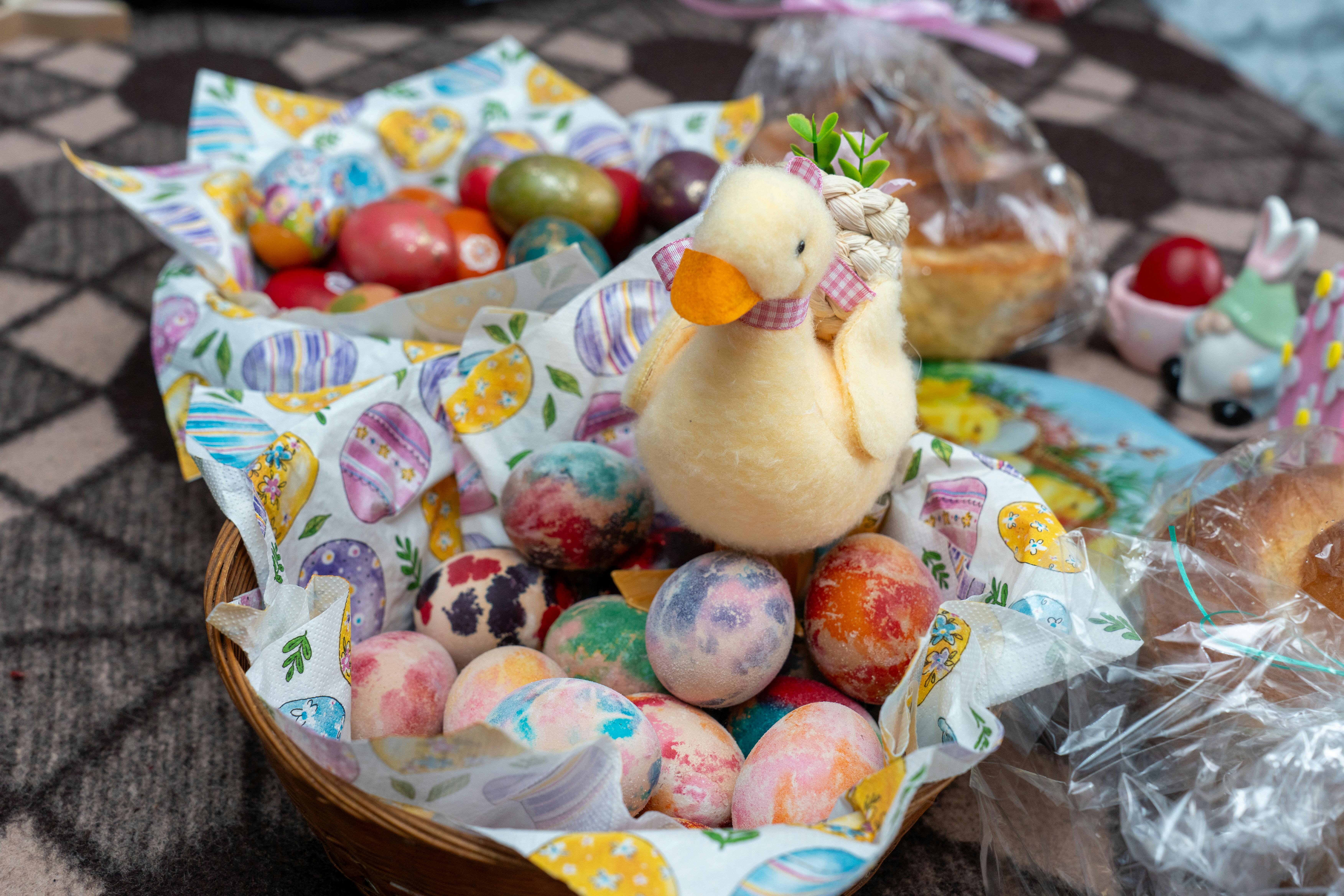 Colorful Easter Eggs and Plush Duck in Basket · Free Stock Photo