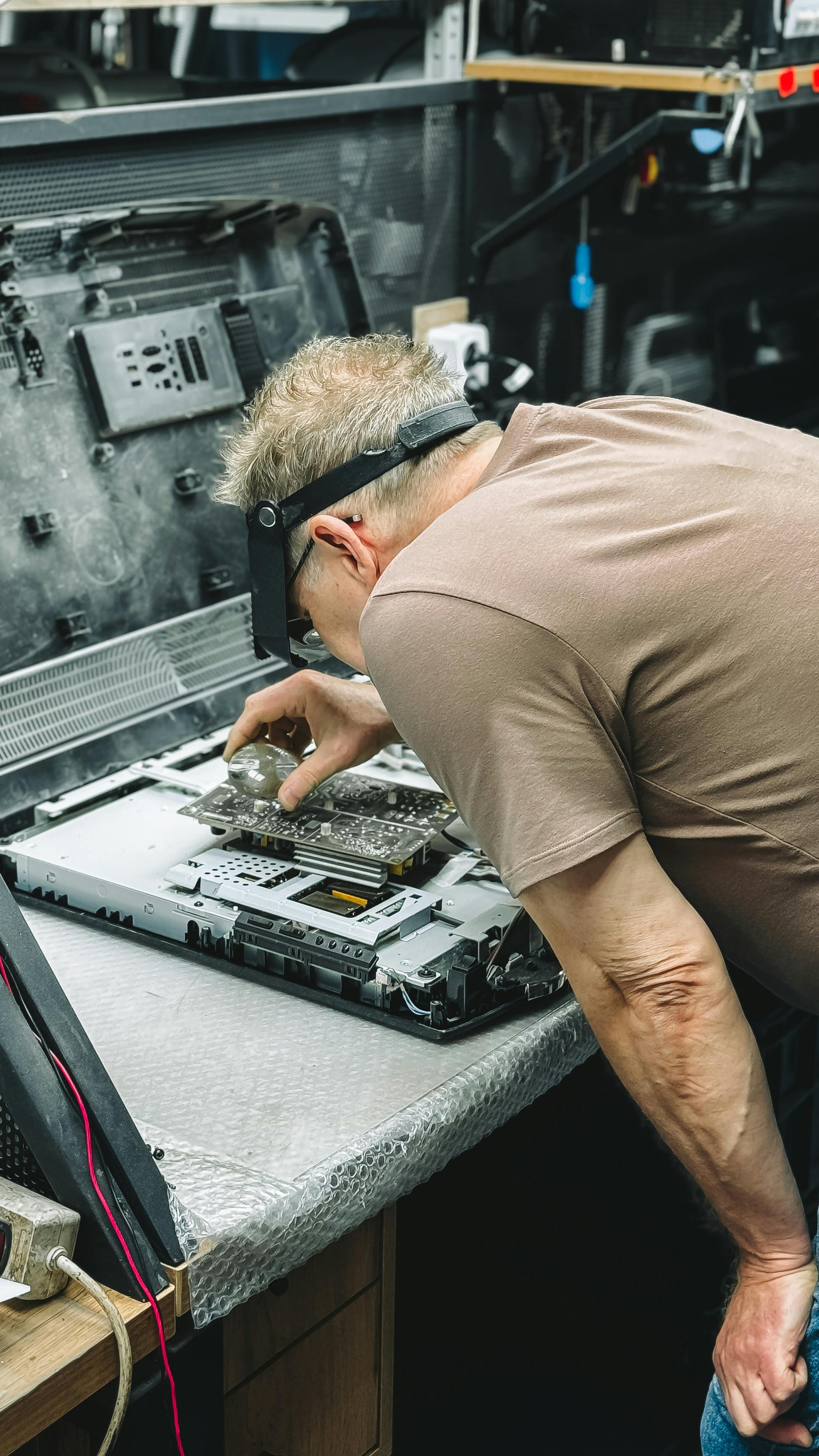 A man is working on an electrical panel · Free Stock Photo