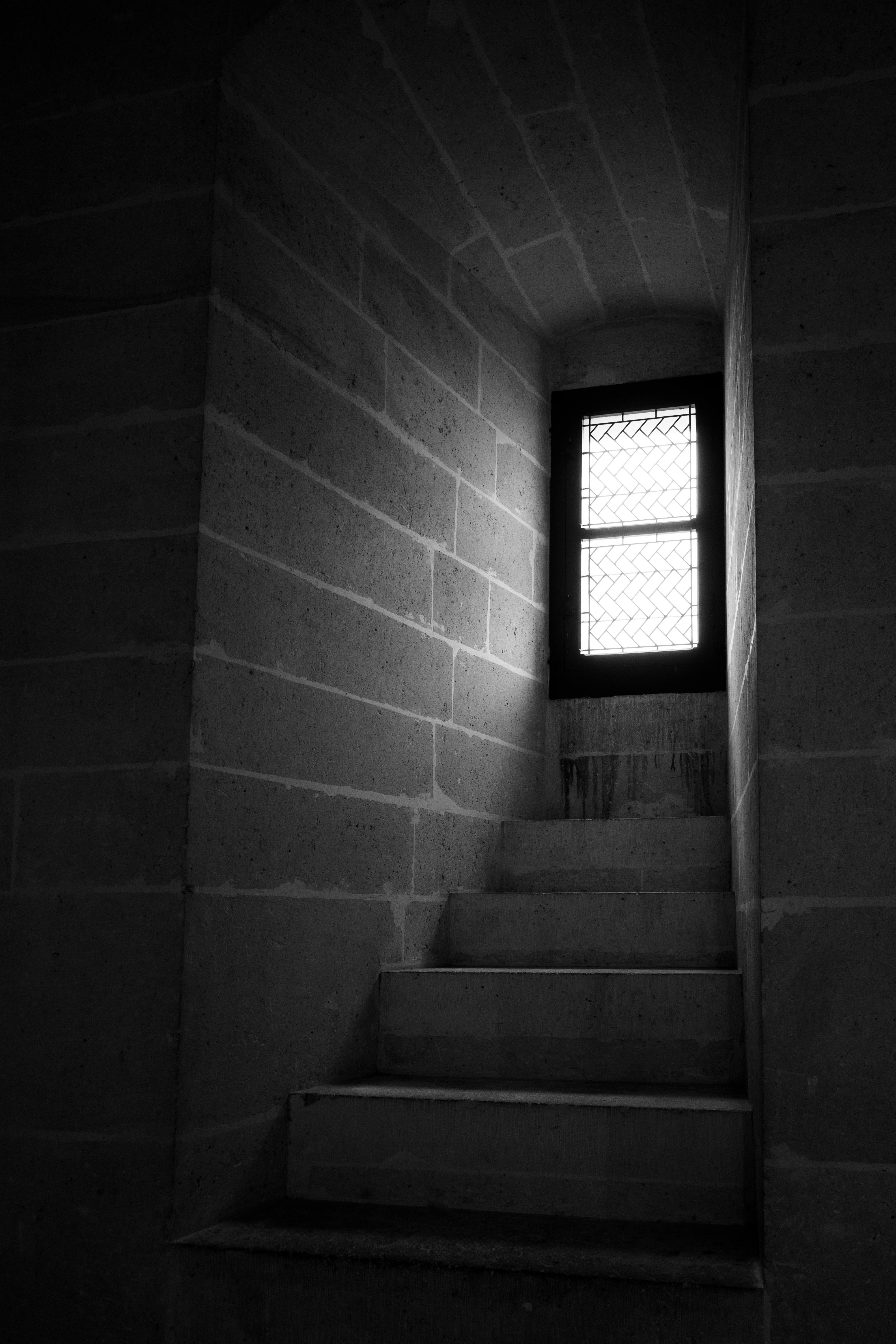 Dimly Lit Stone Stairway in French Castle · Free Stock Photo